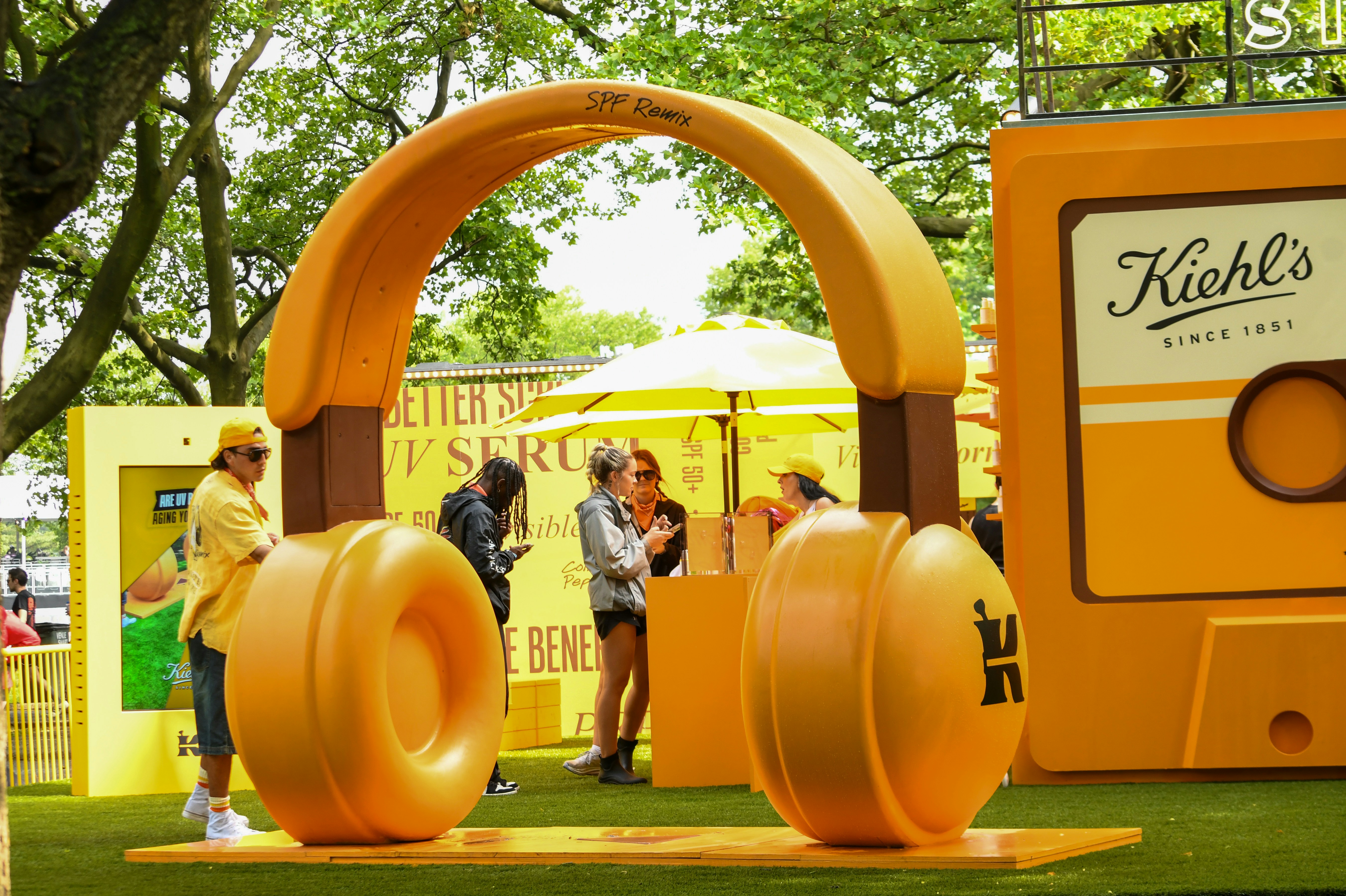 Giant headphones stand next to a cassette display.