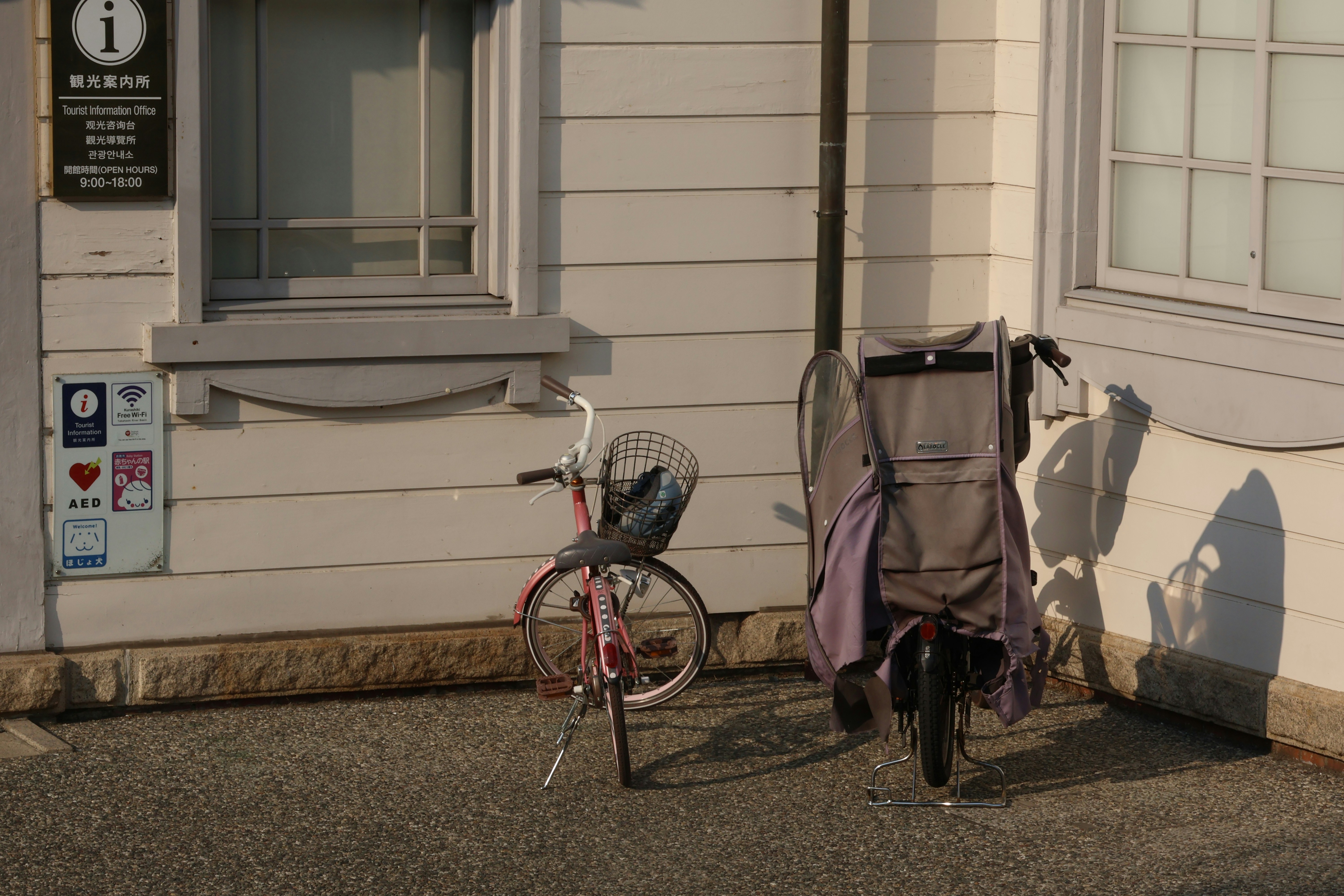 Red Bicycle in a Quiet Courtyard: Shadow Play and a Draped Backpack