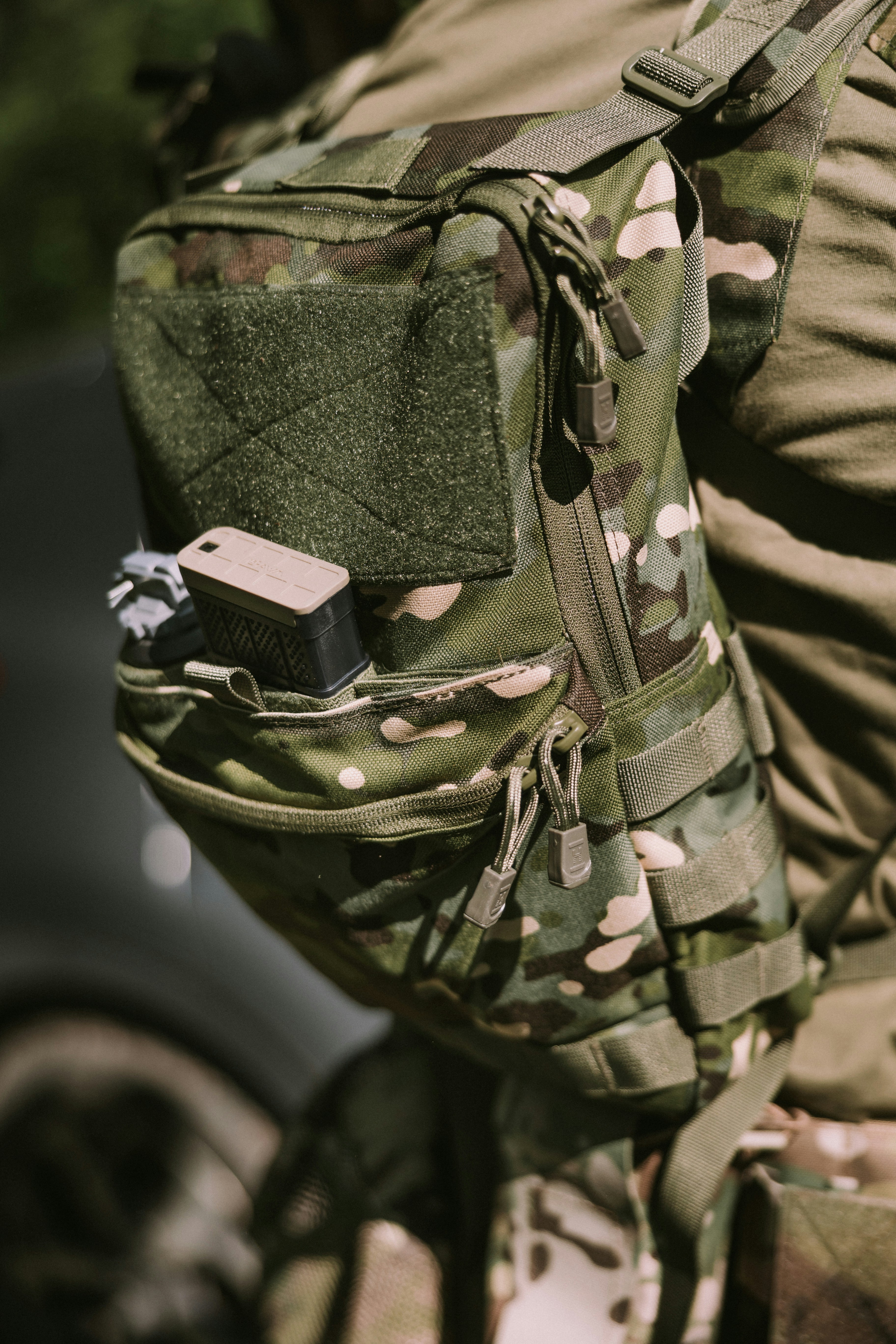 A military-style backpack with camouflage pattern. photo – Free ...