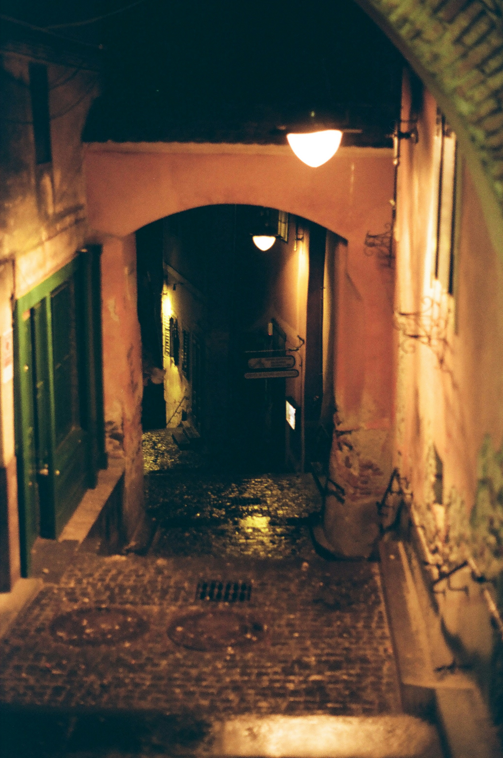 Alley | An illuminated alleyway glows in the night.