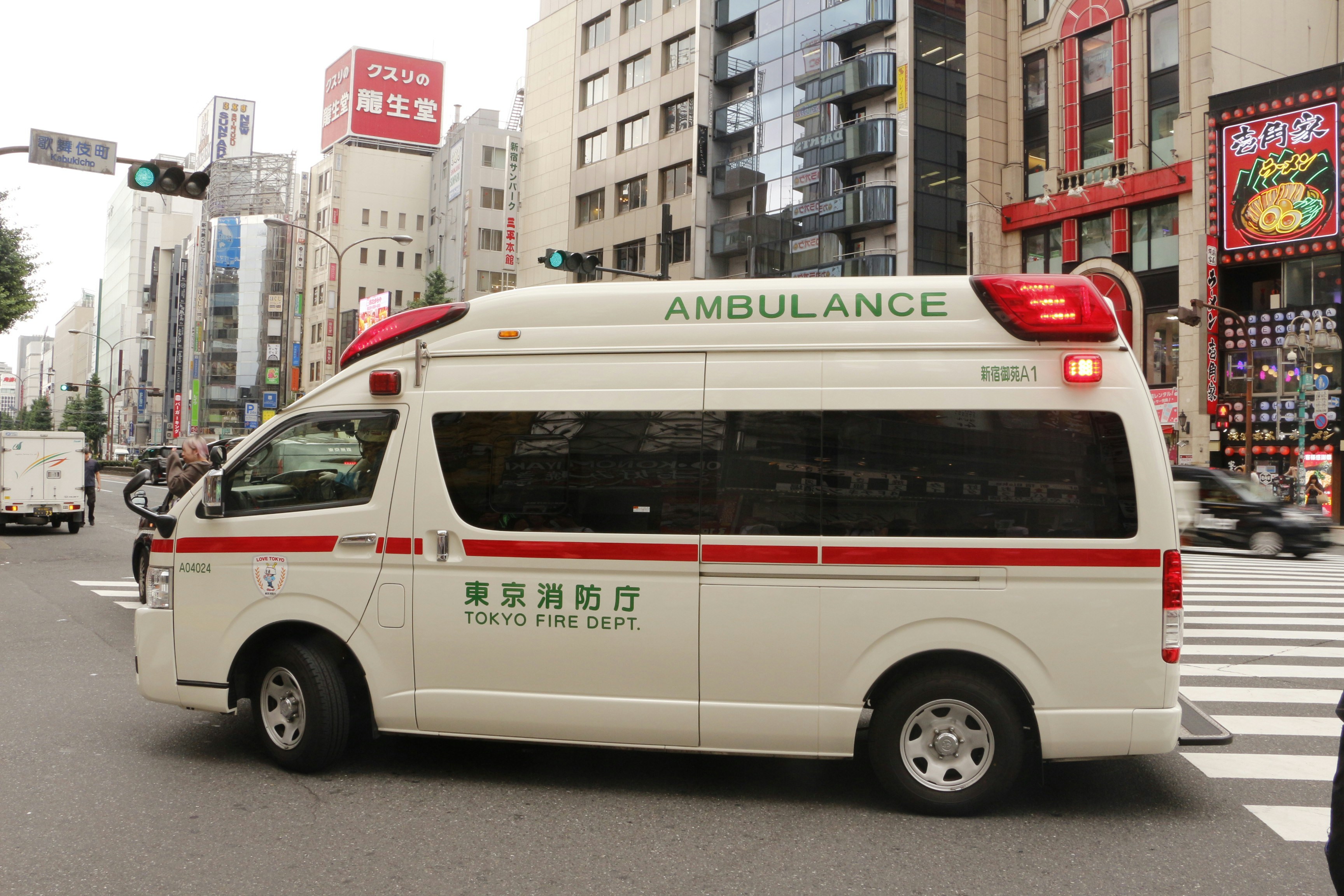 Ambulance on a Busy Tokyo Street: Morning Silver and Red in Motion