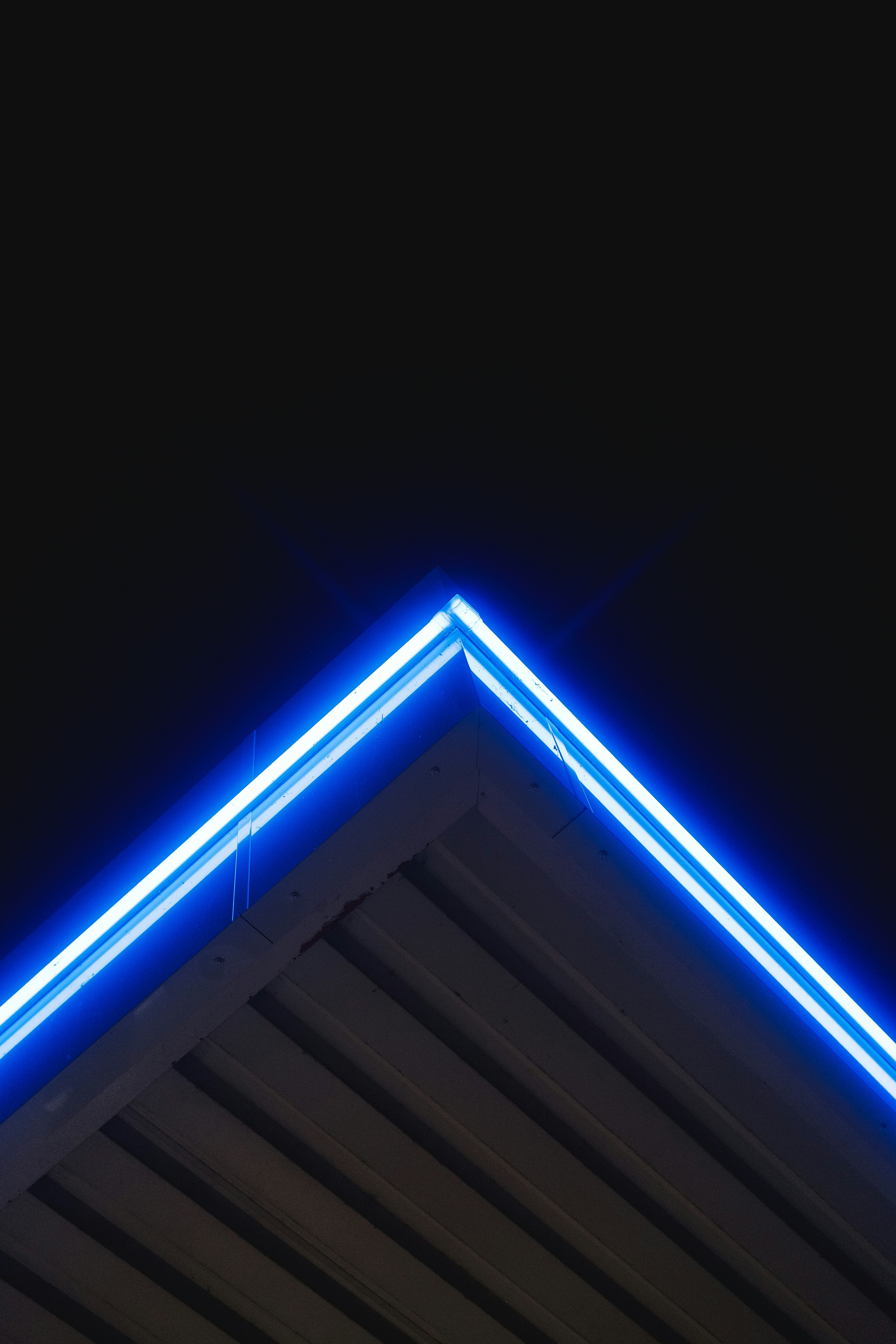 Blue neon lights illuminate an angled roof. photo – Free Building Image ...