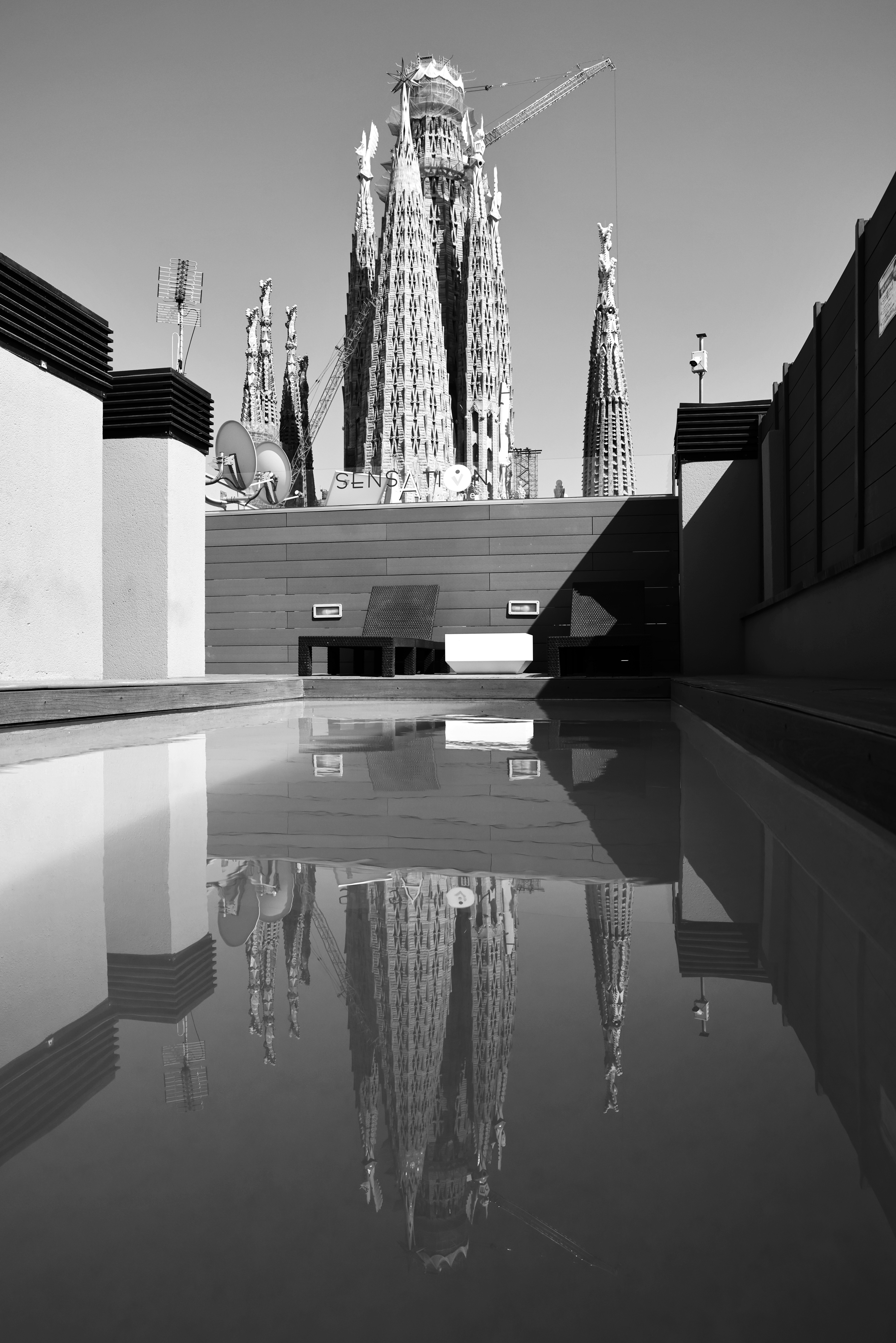 Rooftop Mirror: Gaudí Spires Rising Over a Quiet Terrace