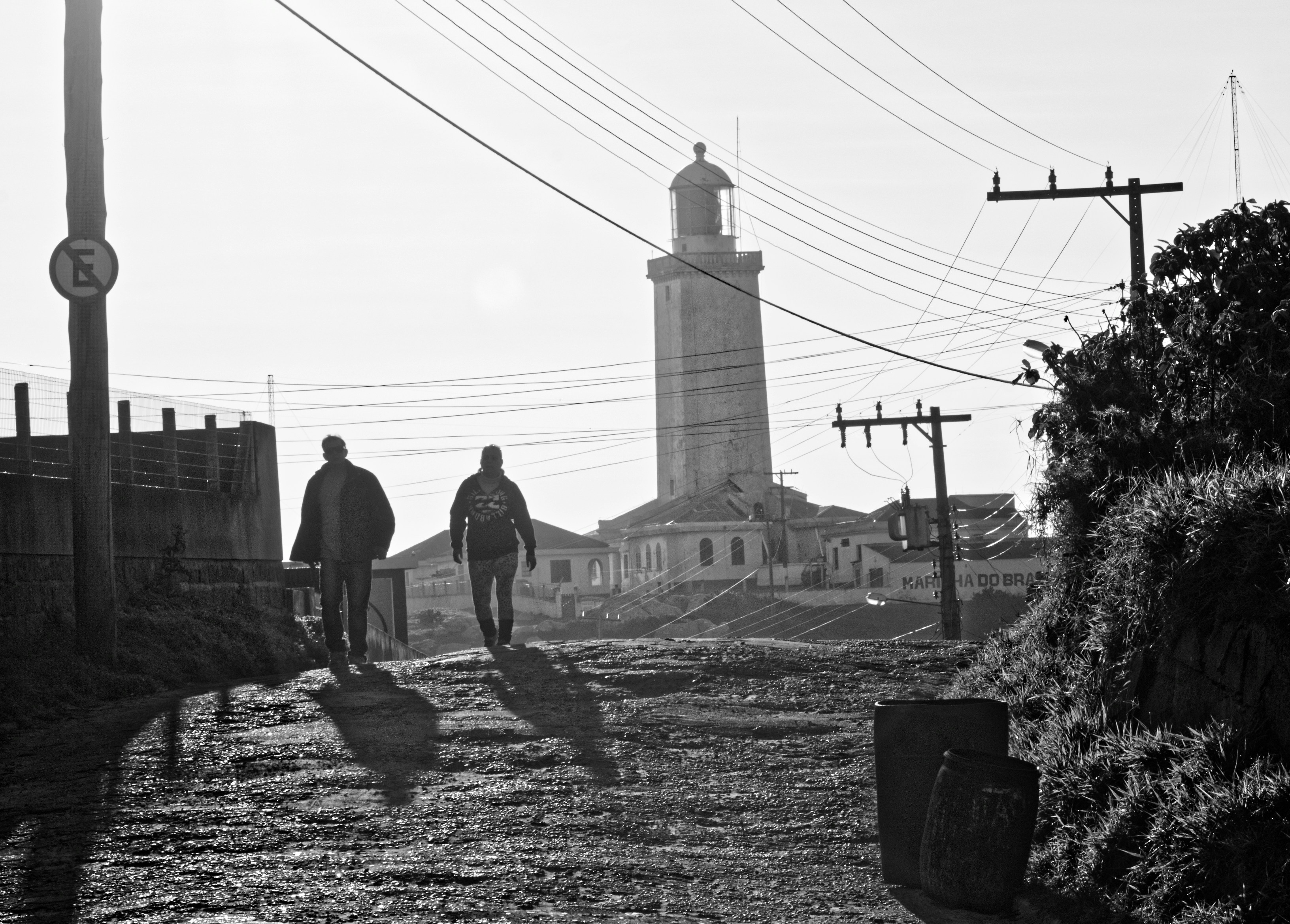 Cobbled Path to the Lighthouse: Long Shadows under Crossing Wires