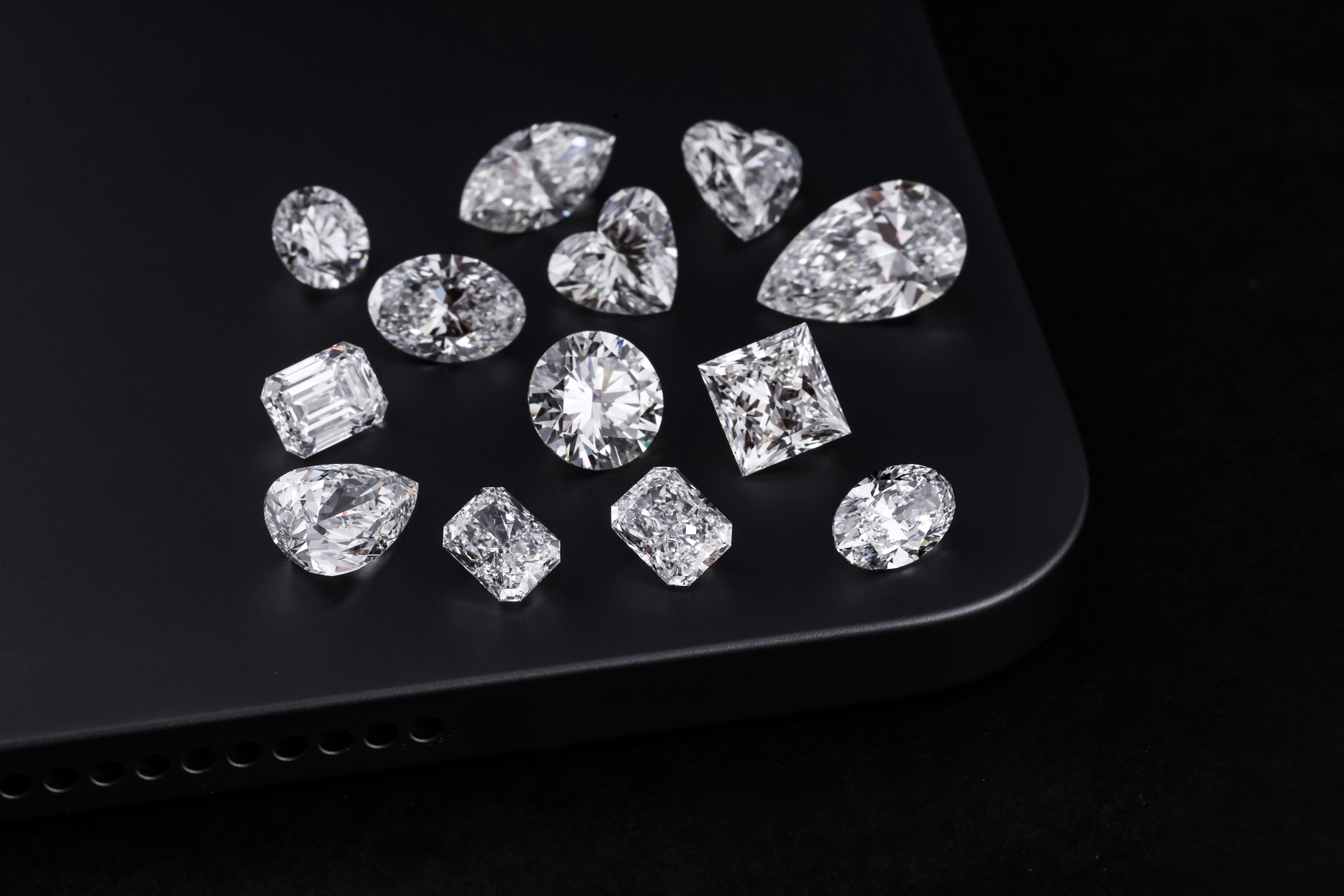 Diamonds of various shapes are on a black surface. photo – Free Luxury ...