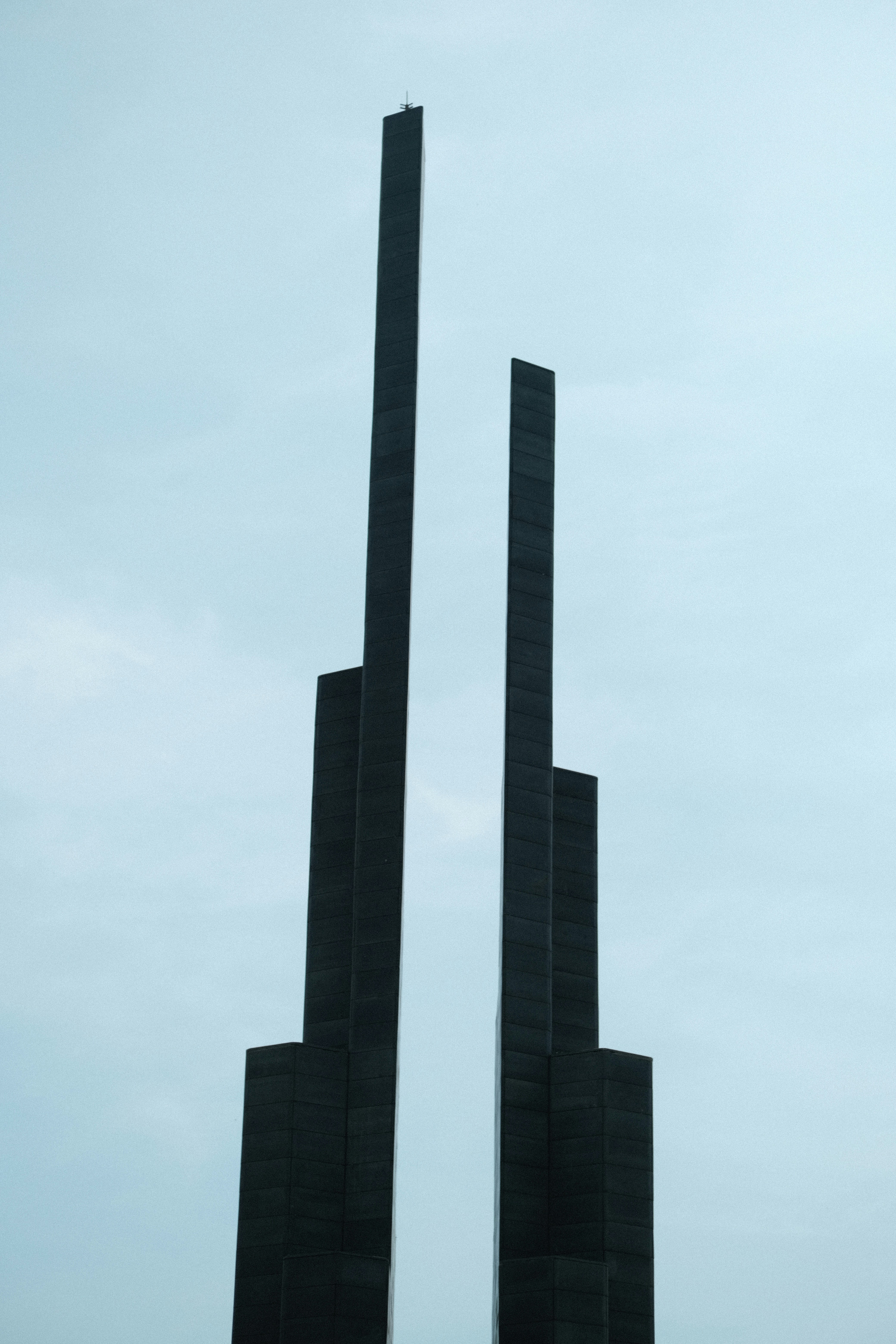 Two tall, dark structures point towards the sky.
