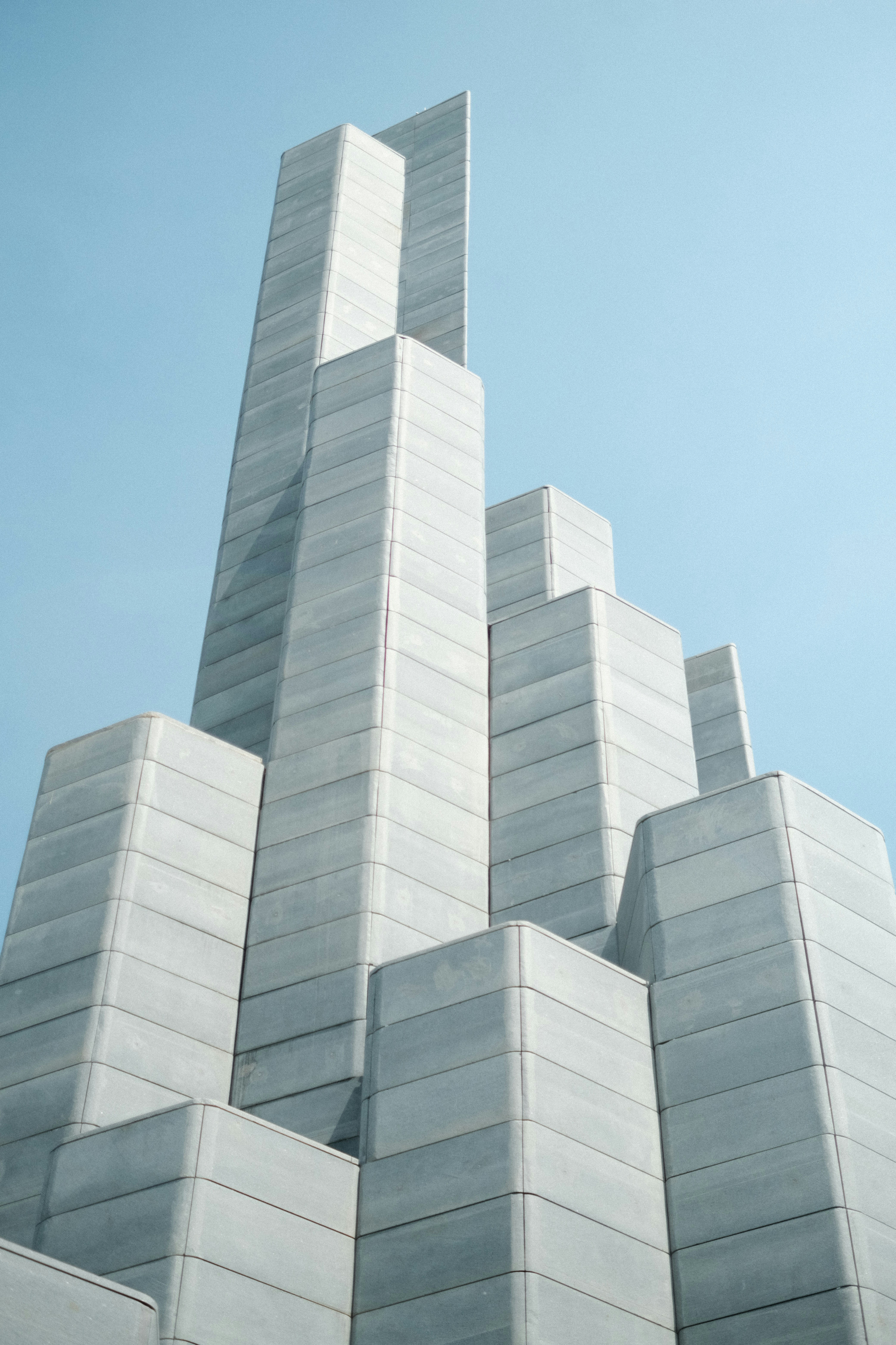 A modern building reaches up towards the sky.