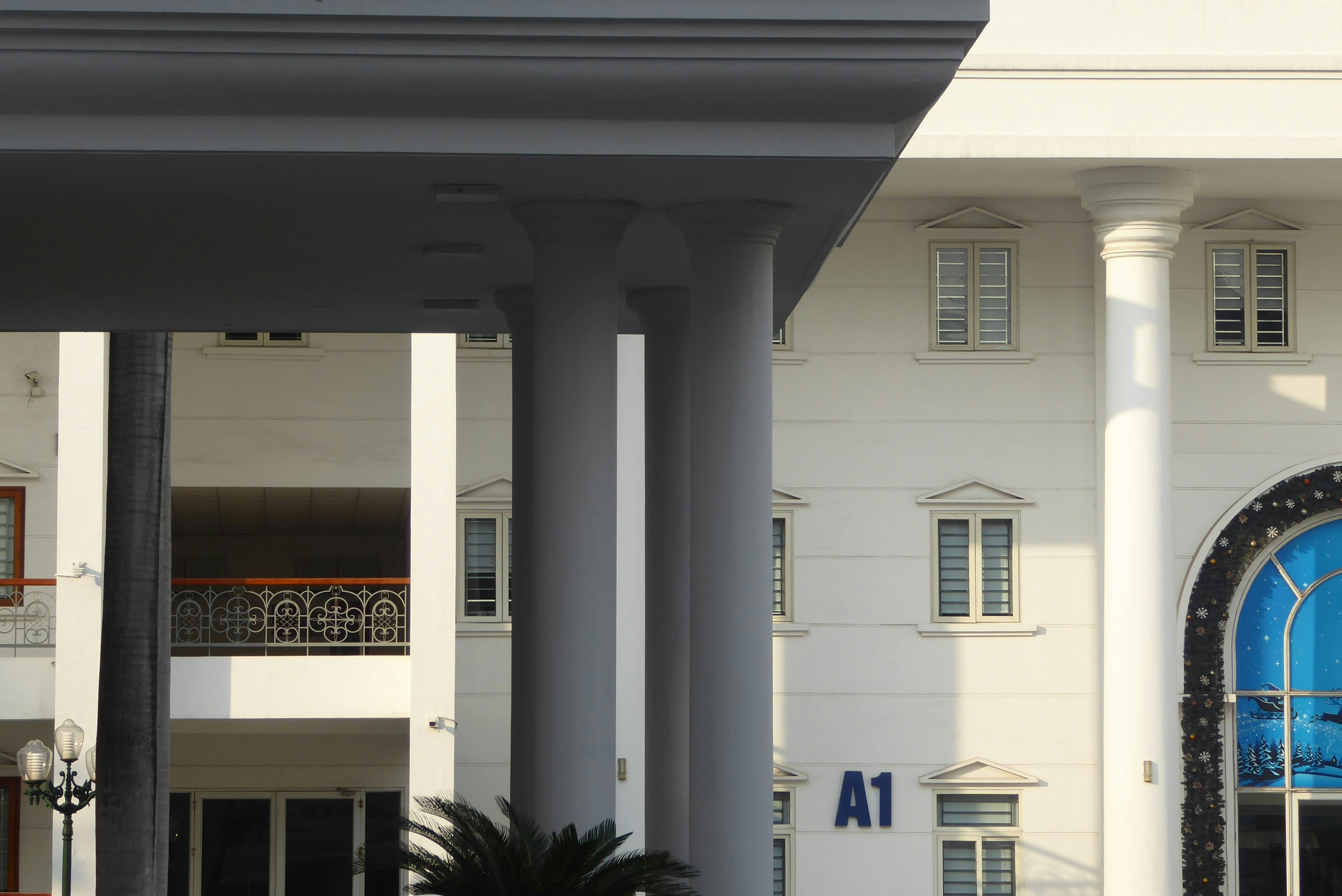 Cerulean Arch Framed by Colonnade on a Modern Facade