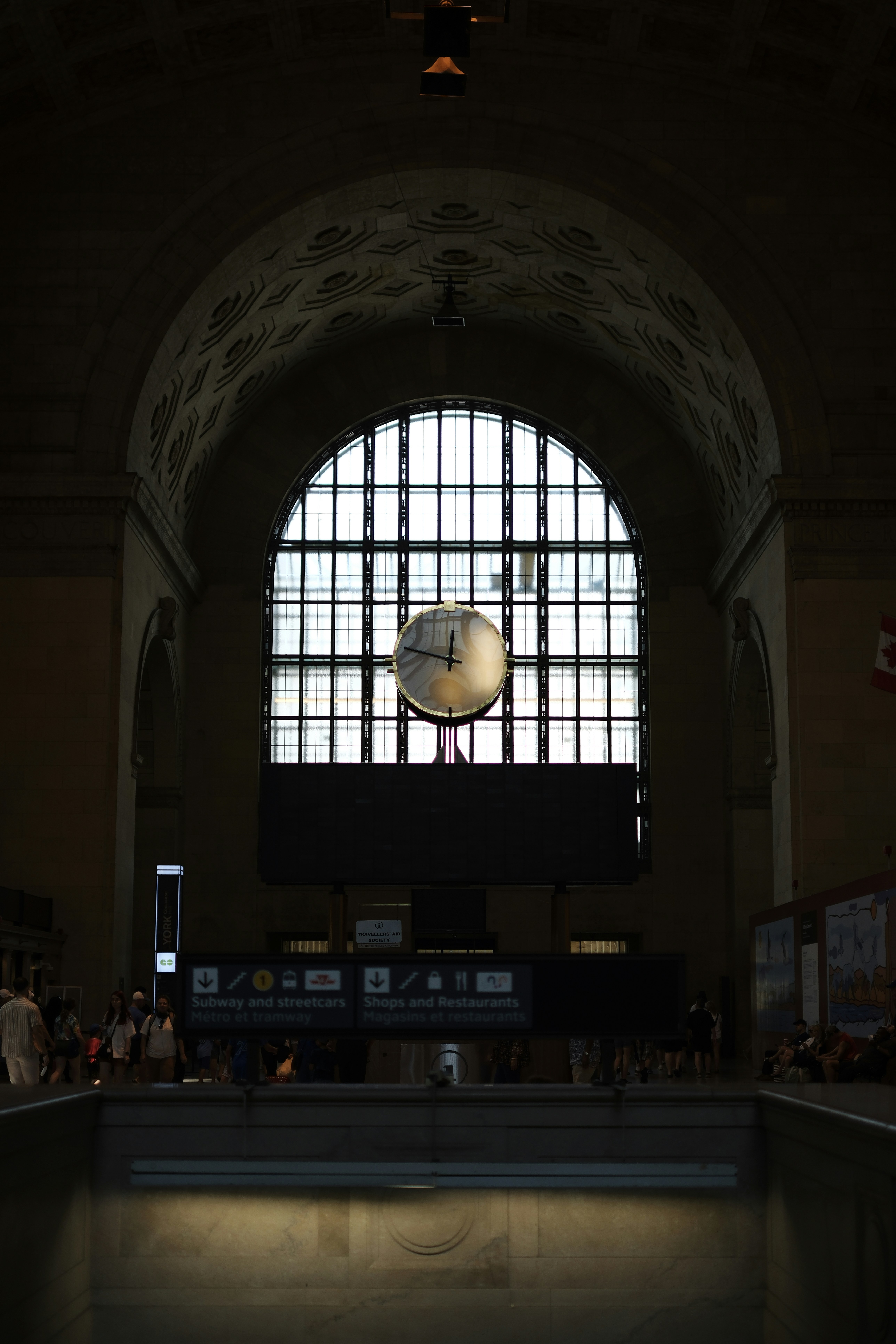 Orb Framed by a Grand Station Window in a Dim Marble Hall