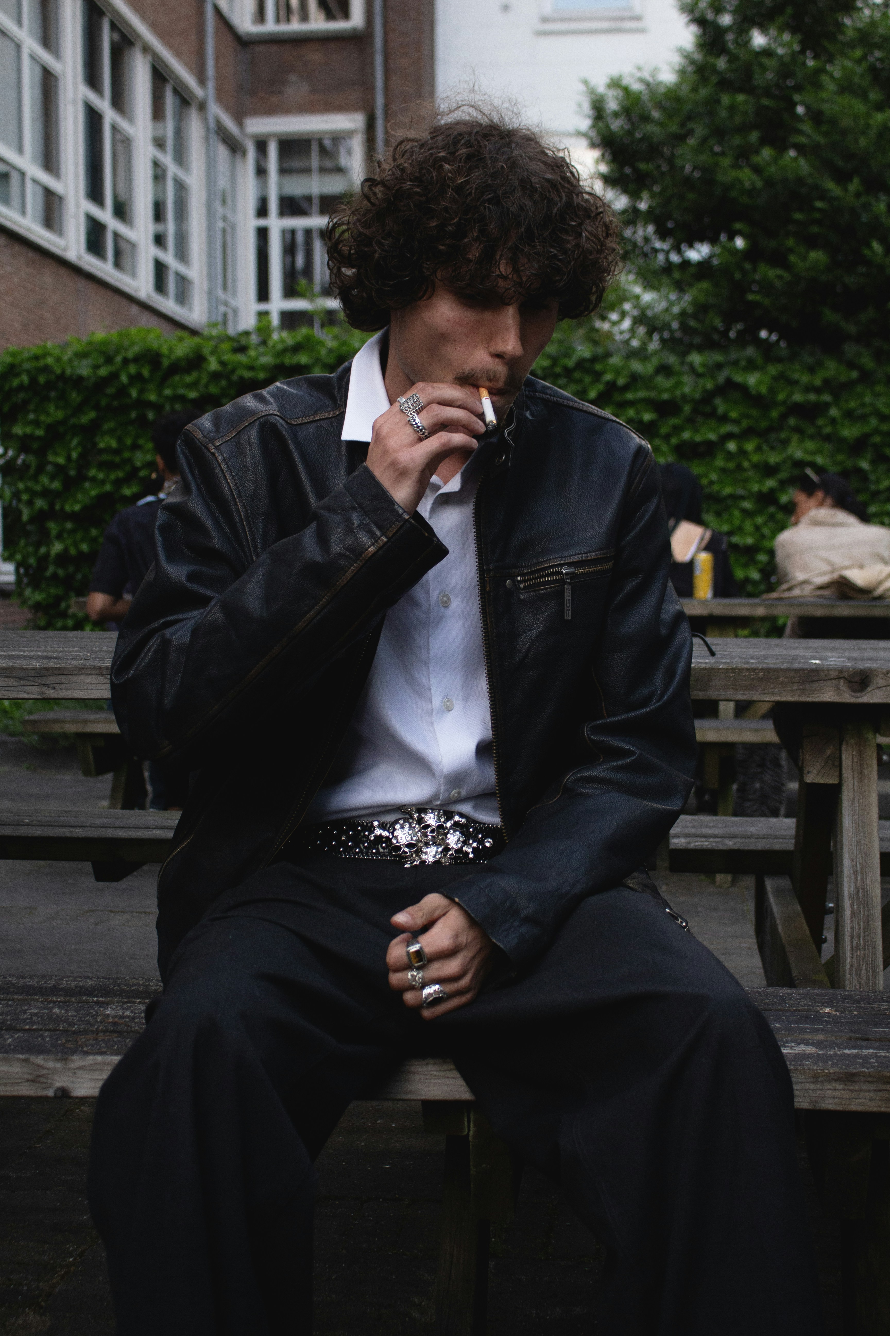 Leather and Smoke on a Quiet Campus Bench