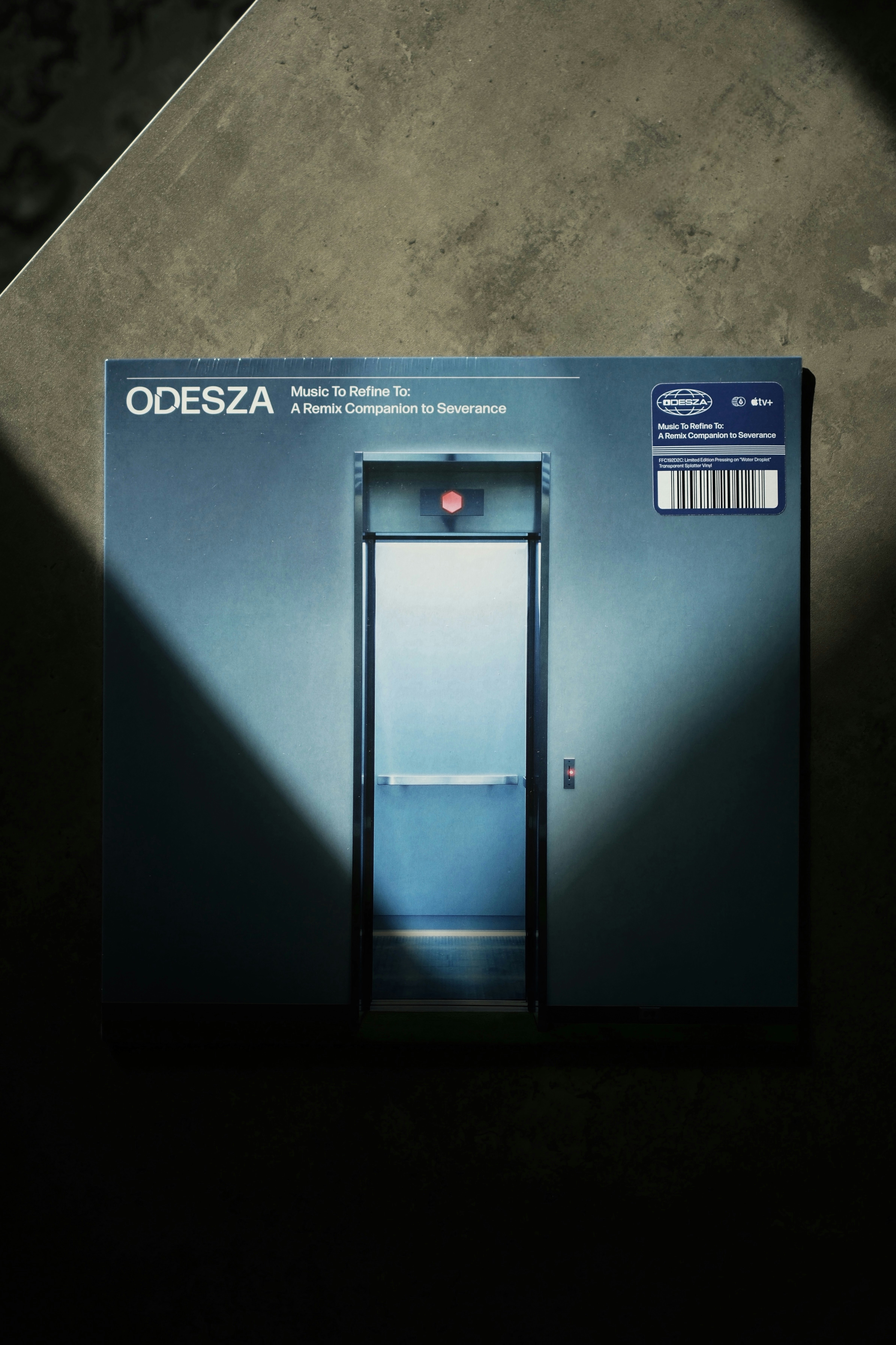 Blue Elevator Door on an ODESZA Vinyl, Lit by a Narrow Spotlight