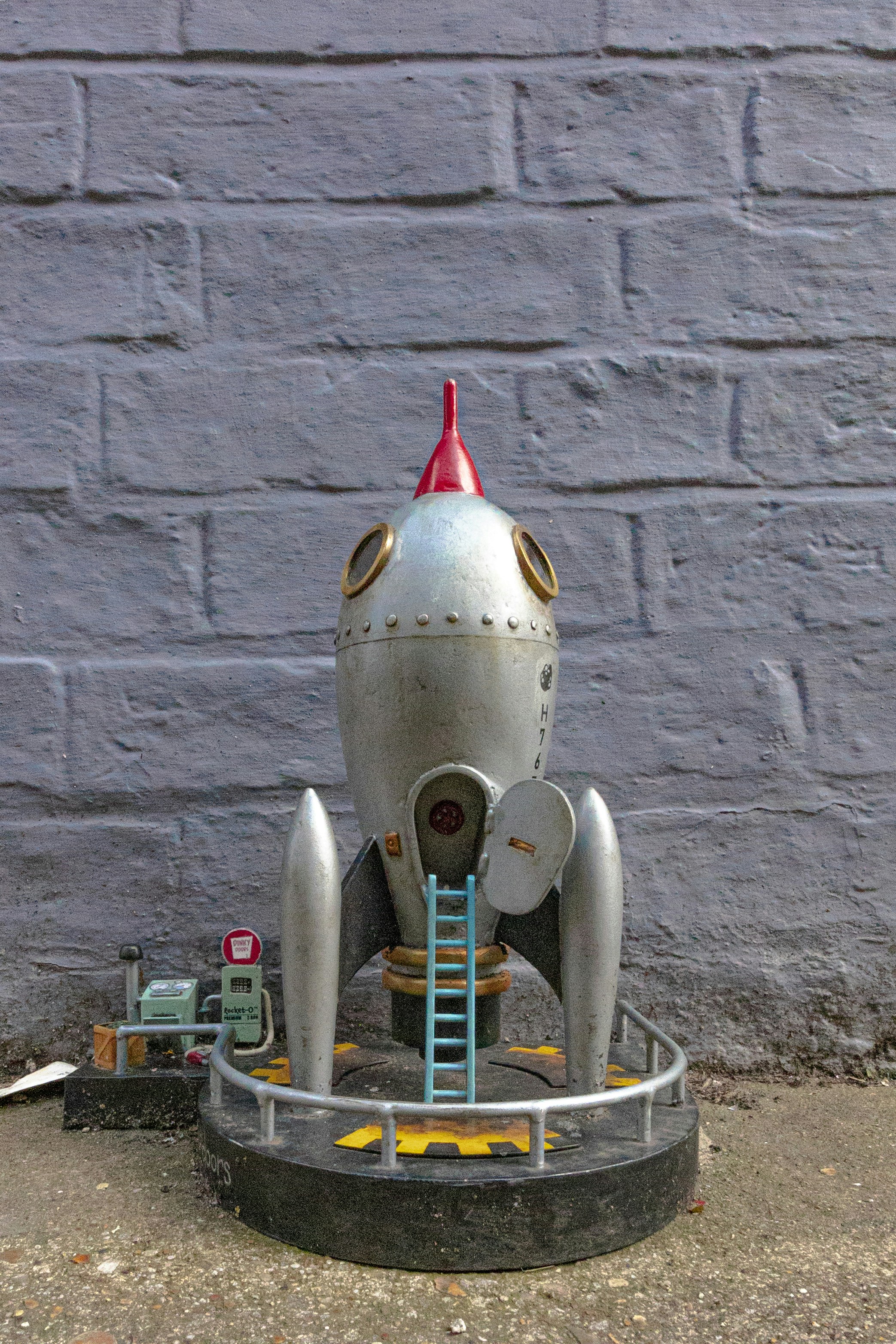 A retro rocket ship stands ready for launch.