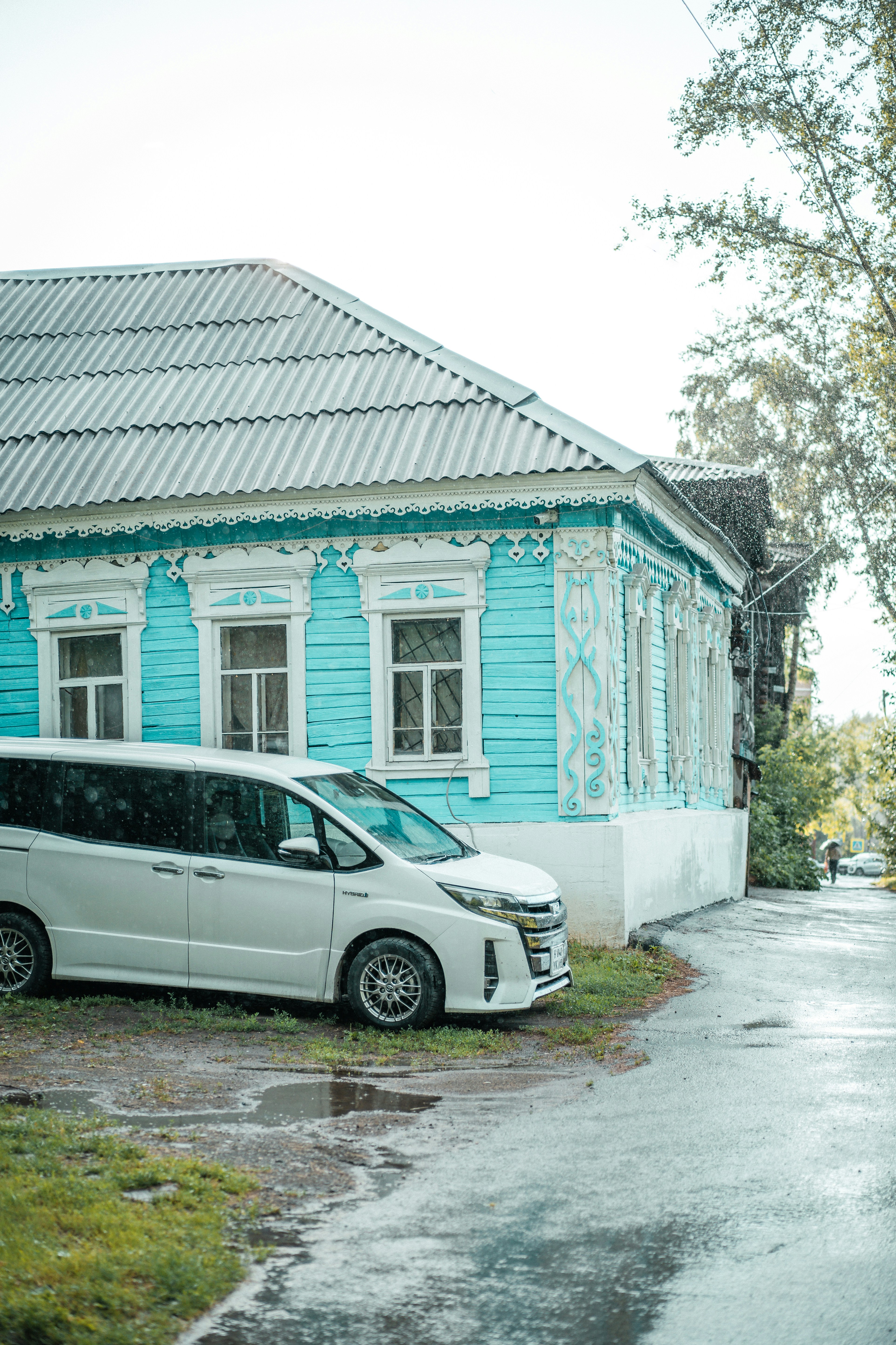 Turquoise Craftsman House and a Quiet Rain-Slicked Street