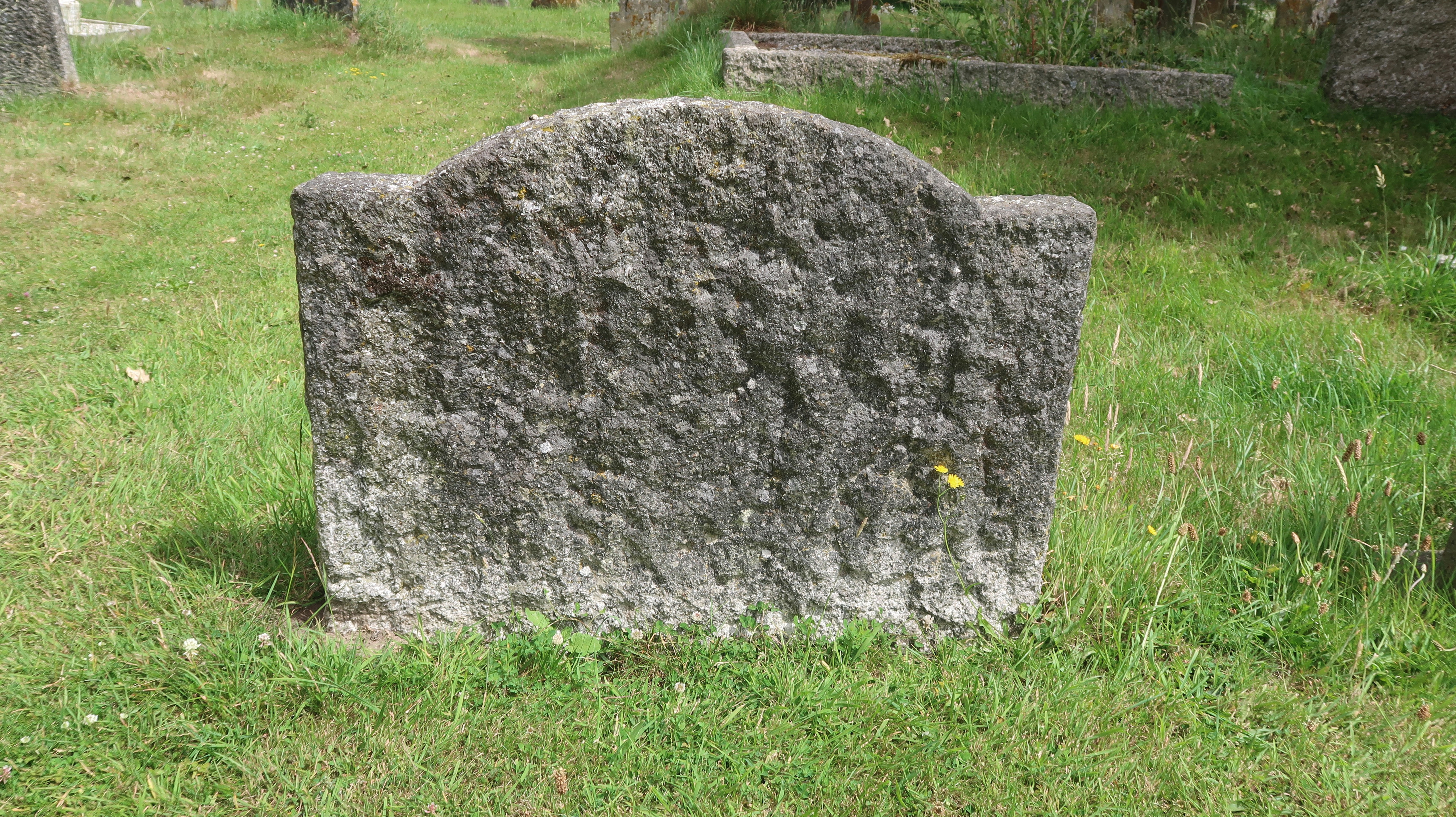 A weathered gravestone stands in a grassy cemetery. photo – Free ...