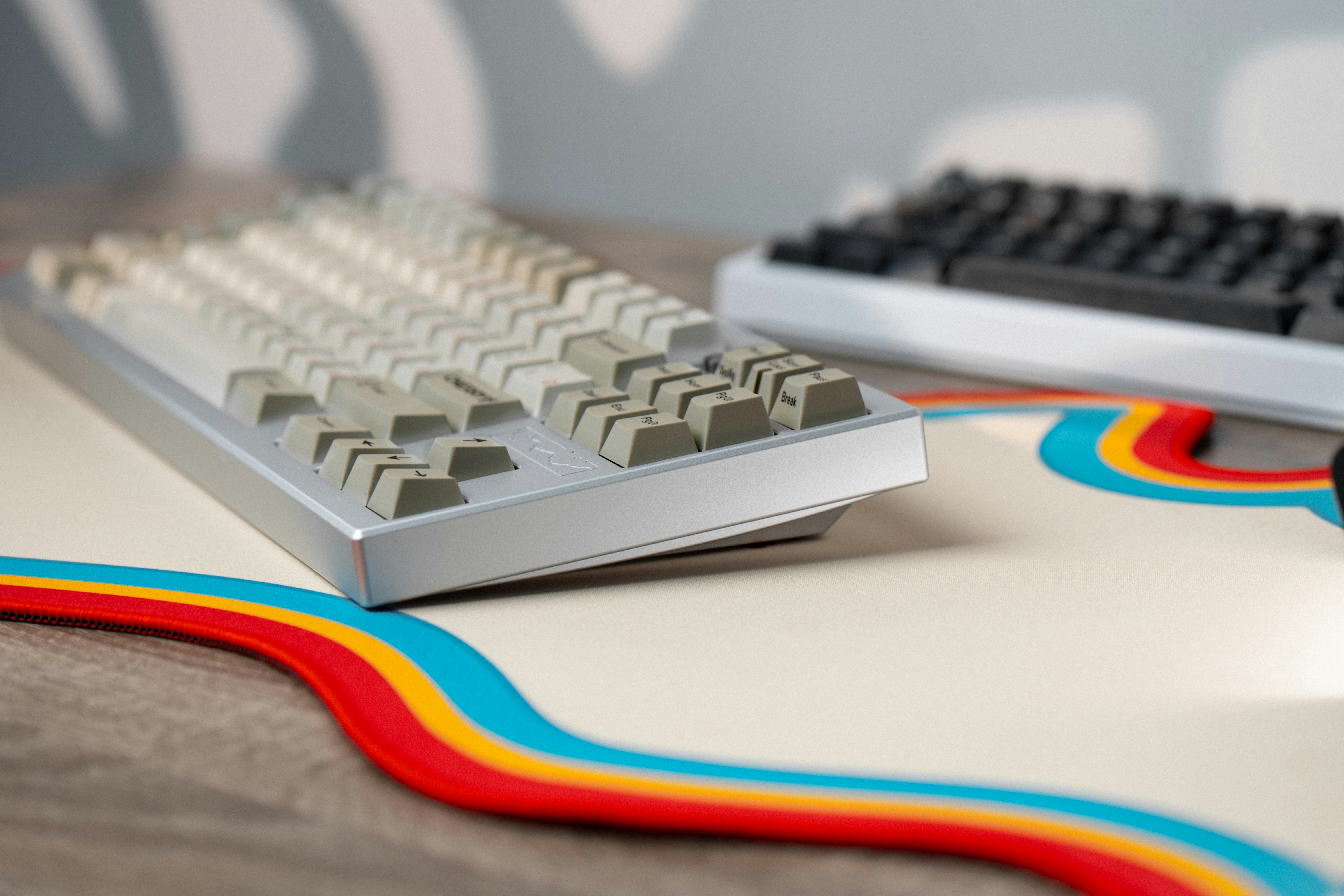 Colorful Retro Keyboard Duo on a Curved Desk