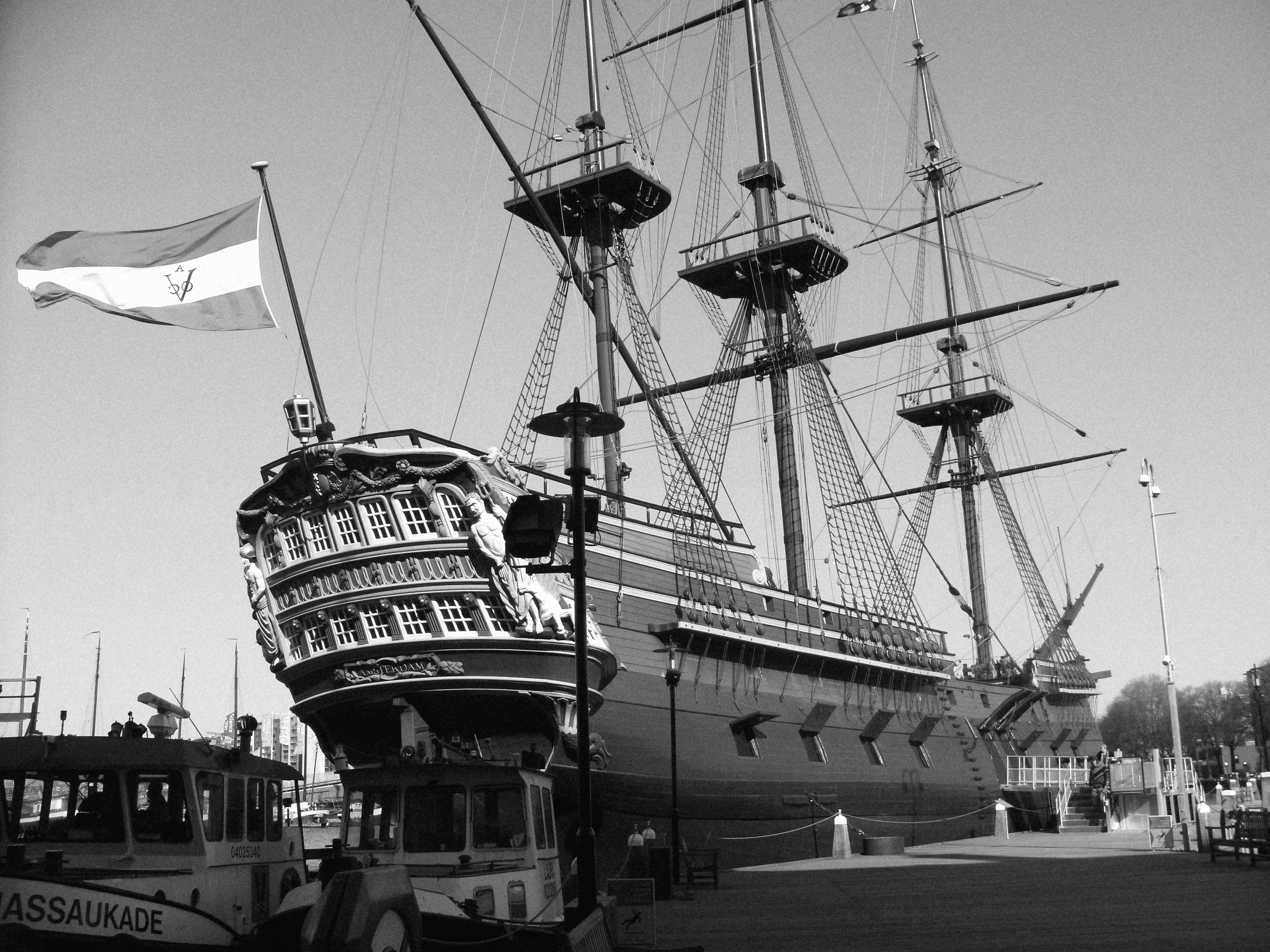 Monochrome Masts at the Pier: A Historic Sailship Resting in Quiet Harbour
