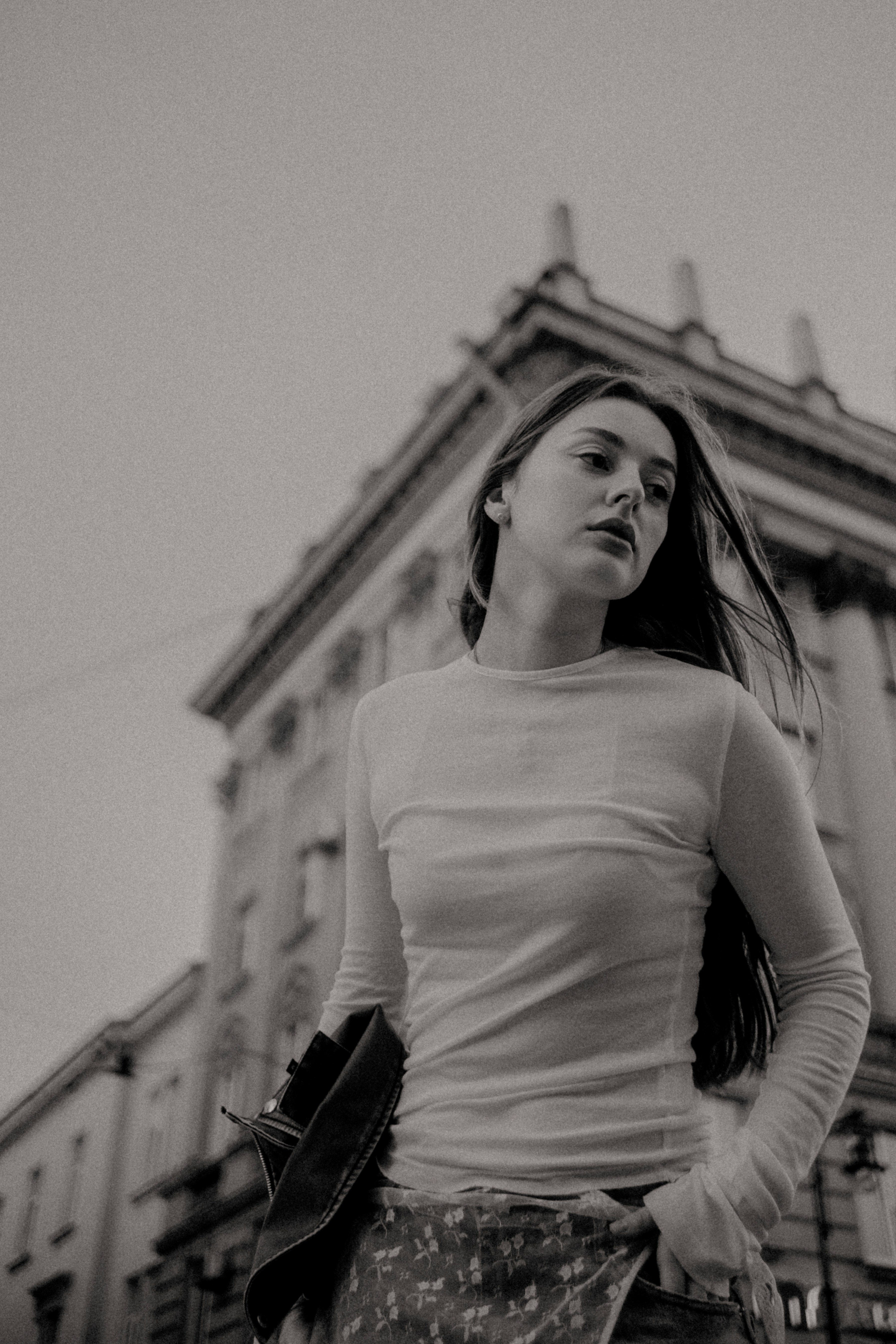 Portrait in a Tilted Cityscape: Quiet Confidence Against a Monumental Facade