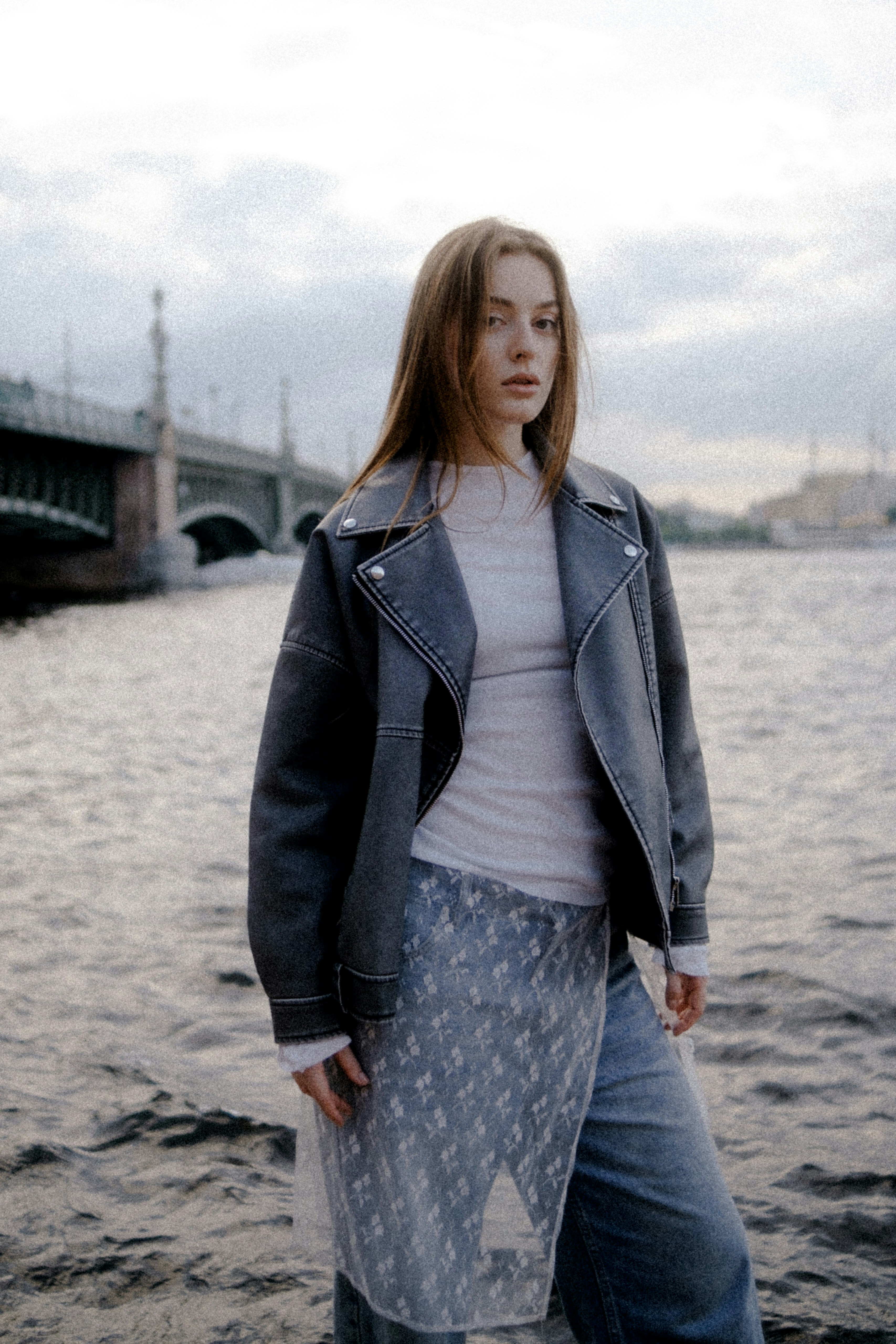 Leather Lines by the River: A Quiet Portrait by the Bridge