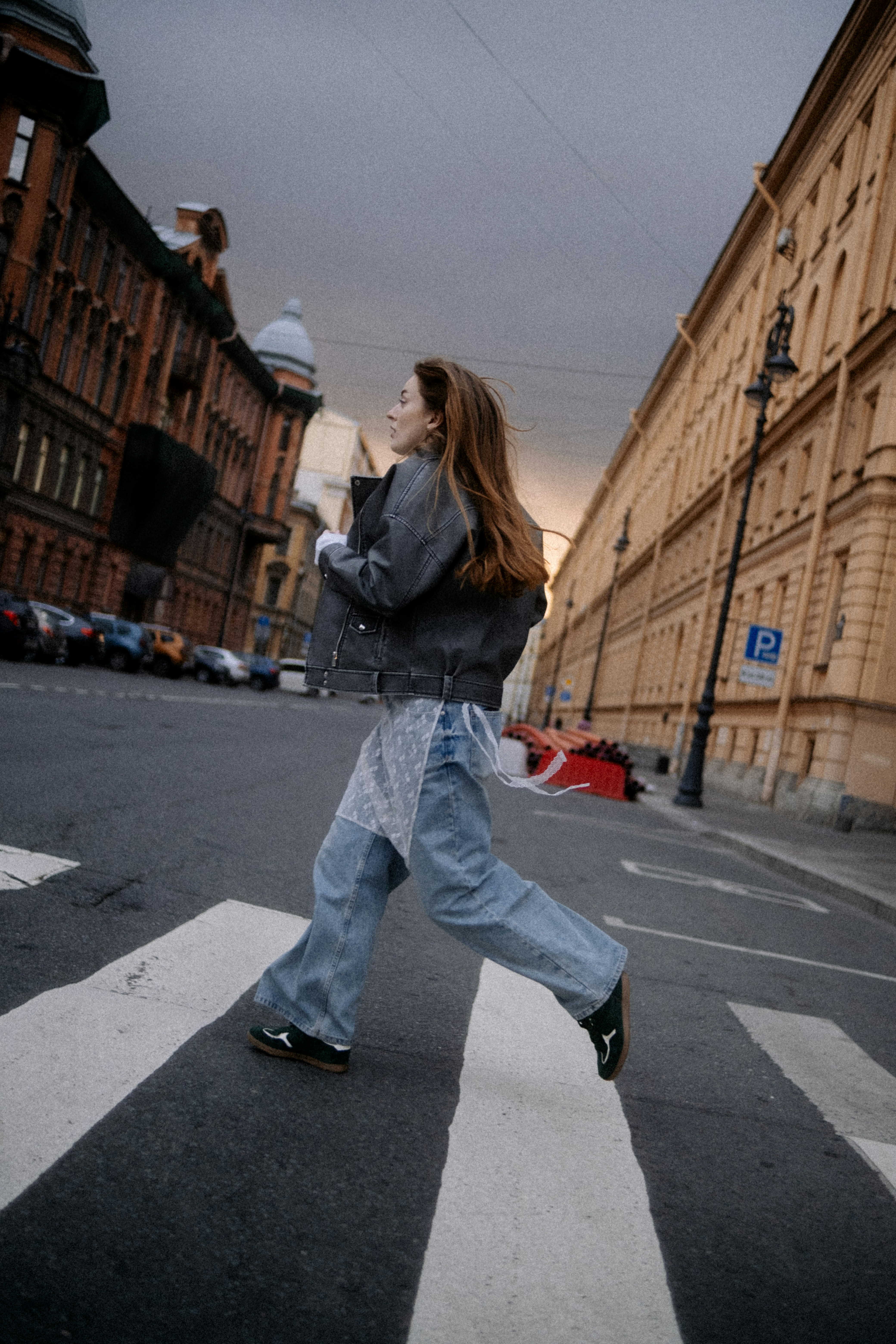 Amber Hour Crossing: Denim in Motion Across a City Crosswalk