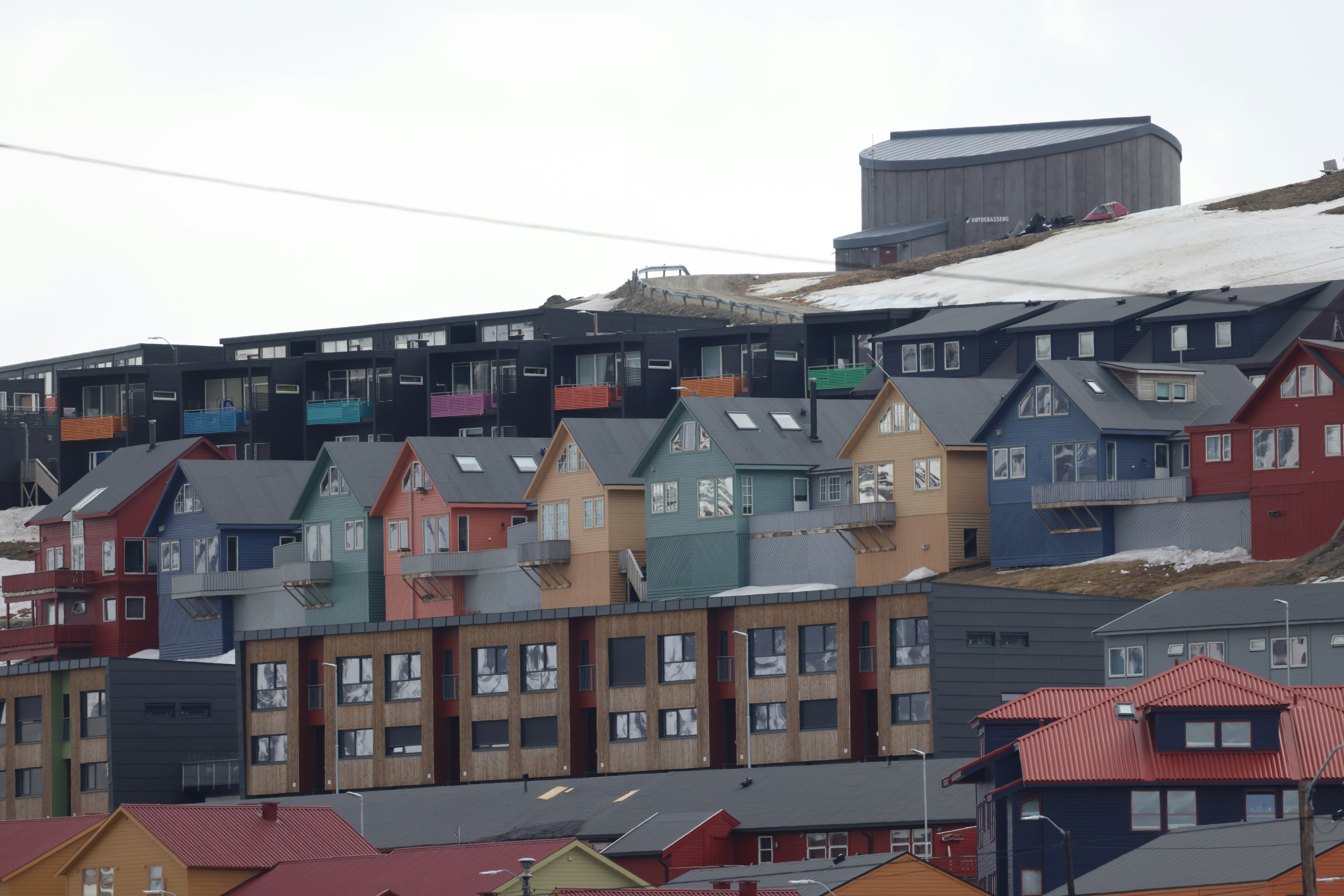 Colorful houses stand nestled on a hillside.