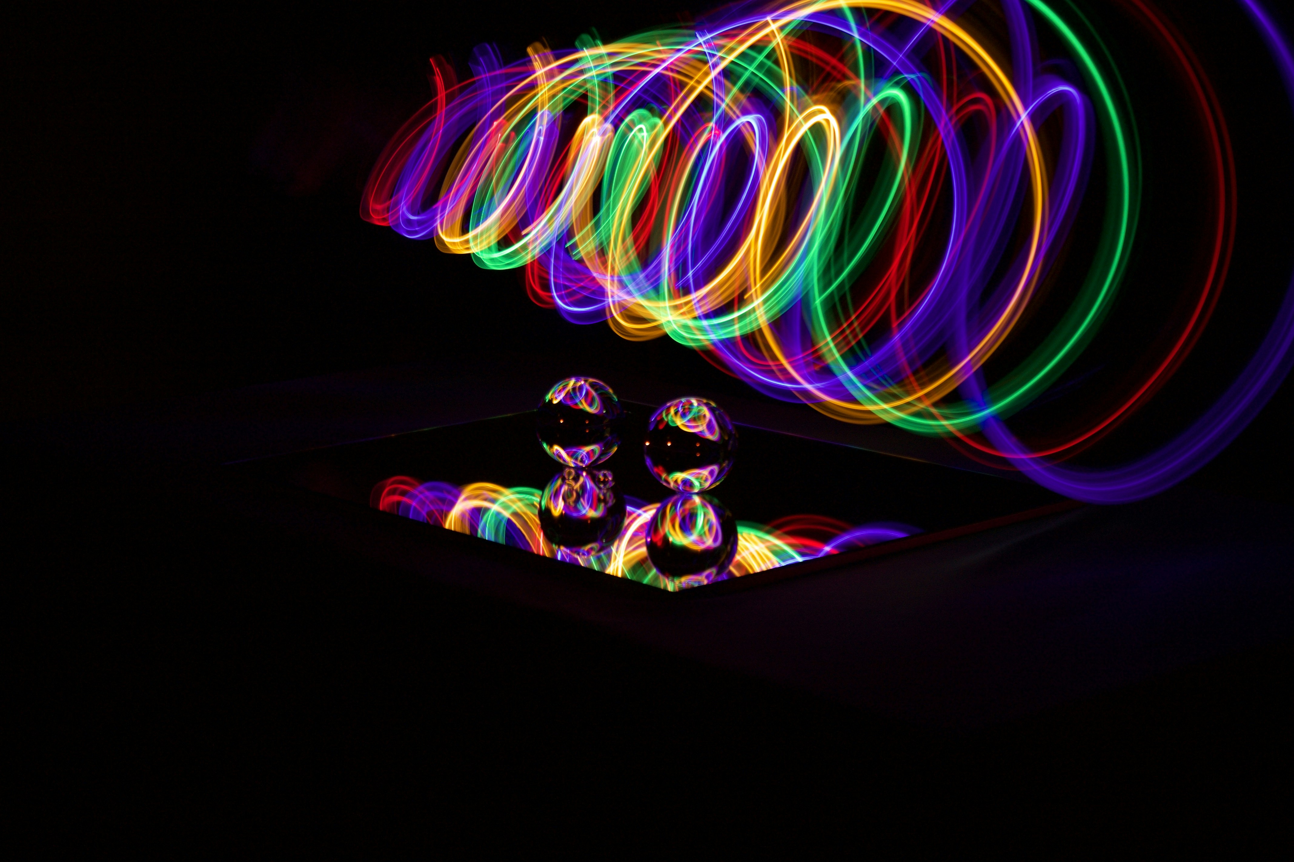 Illuminated Whirls: A Dance of Light and Reflection