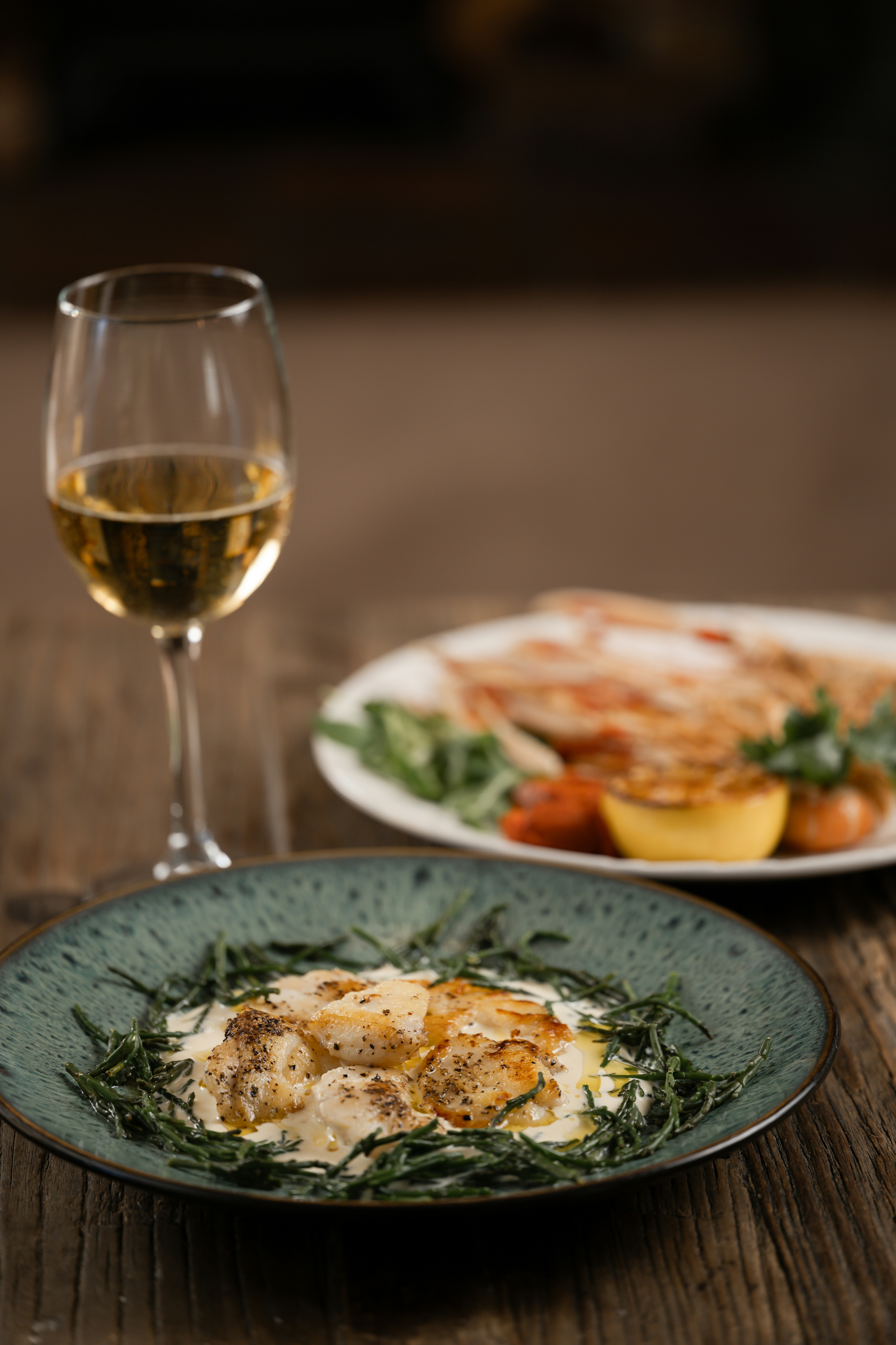 Seafood and wine on a rustic wooden table.