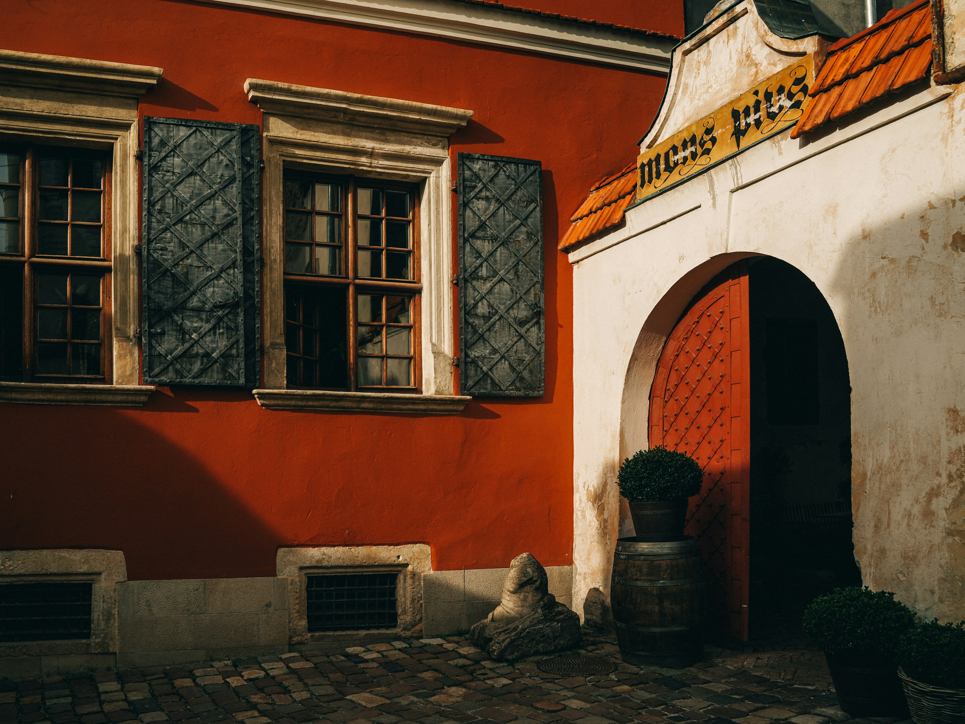 A colorful building with a red door.