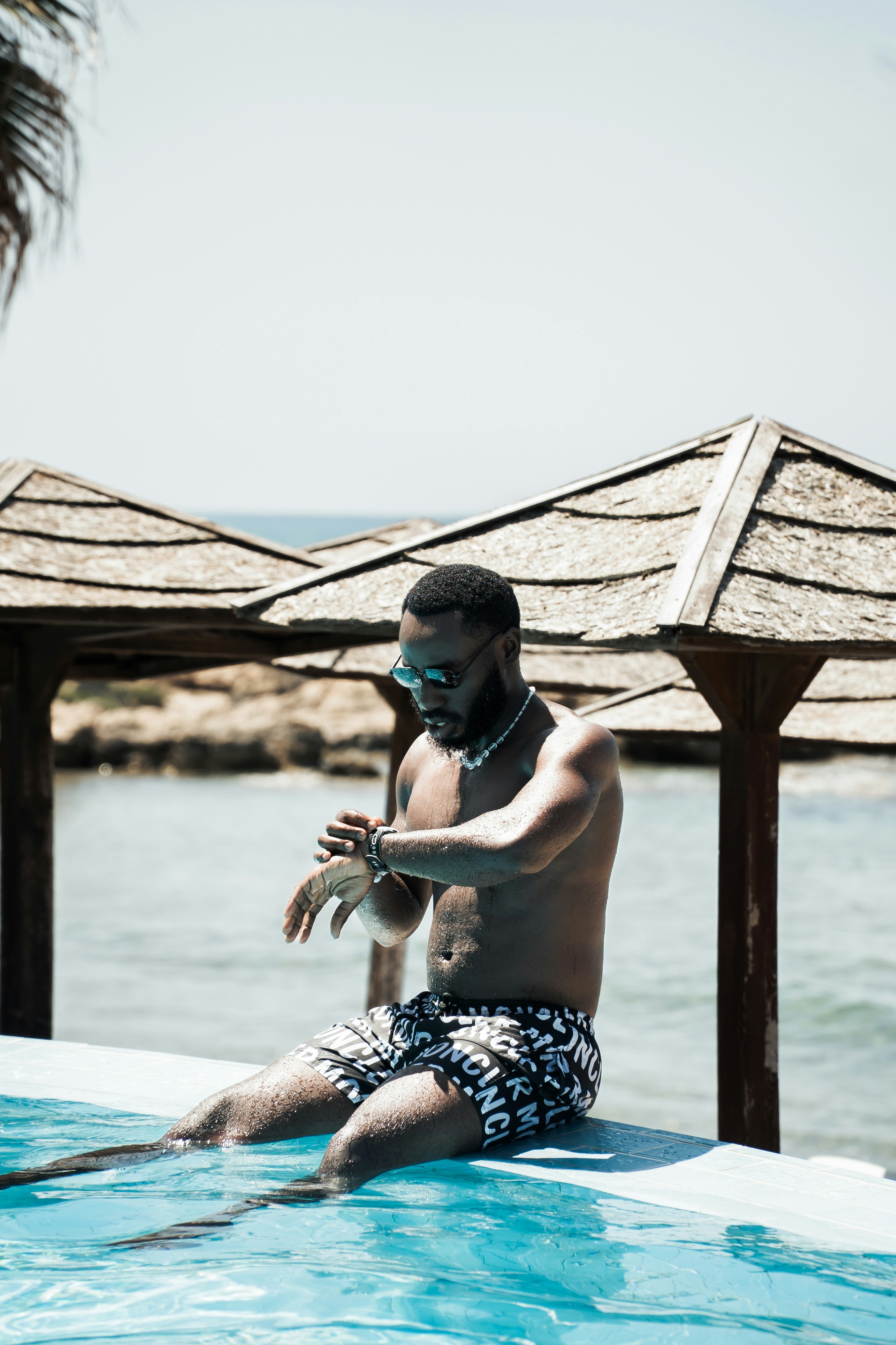 Pool Edge Reverie: A sunlit moment by sea-side cabanas