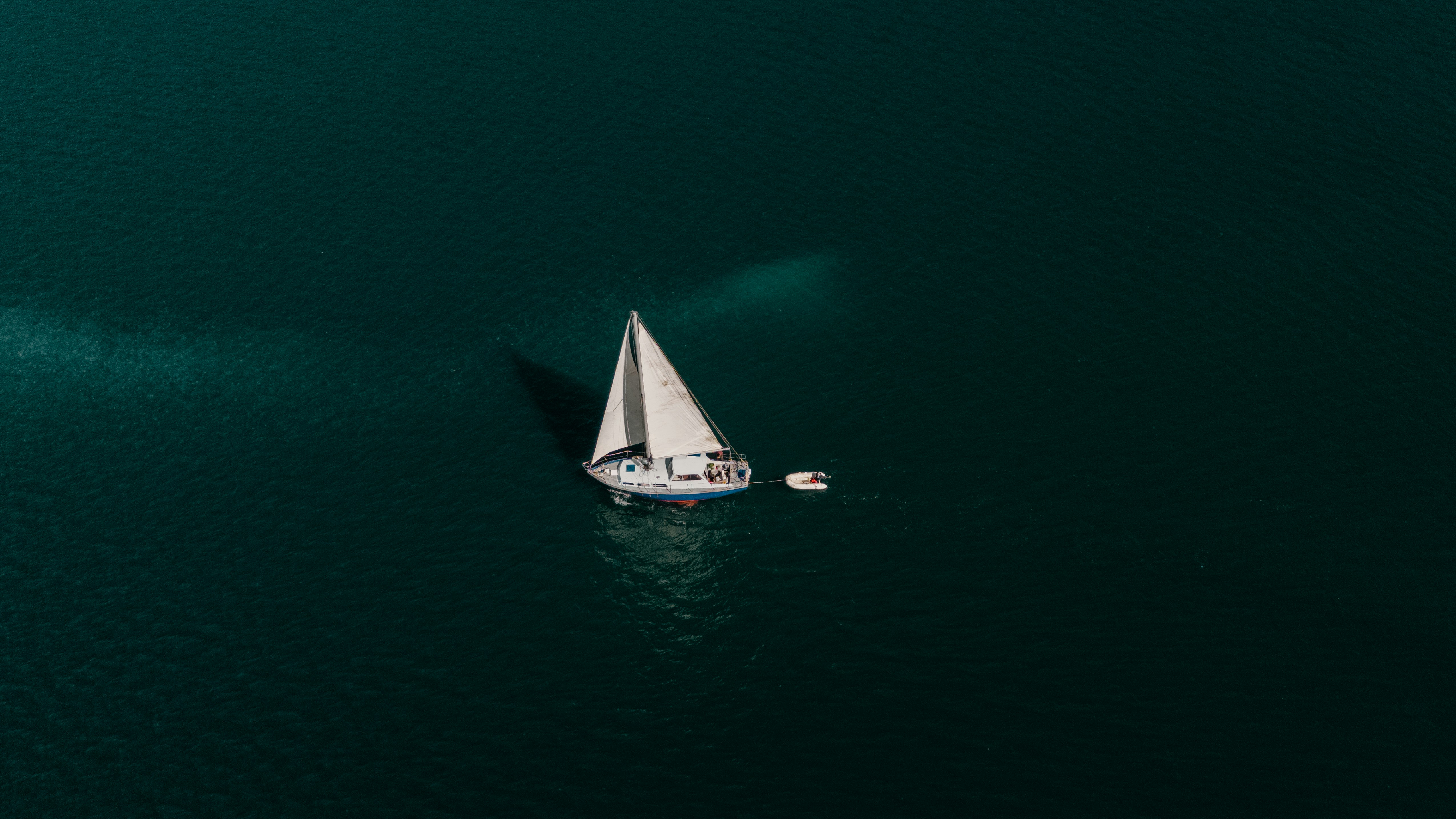 A sailboat glides peacefully across the water.