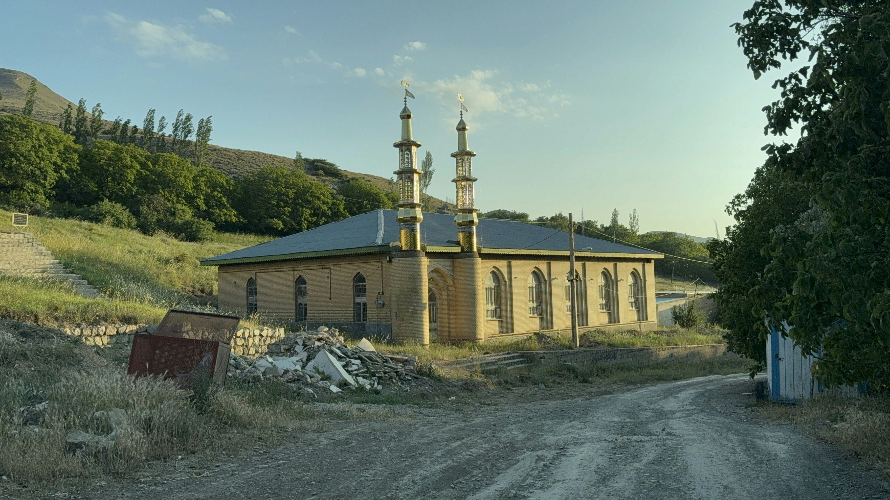 A mosque sits in a rural, grassy landscape. photo – Free Architecture ...