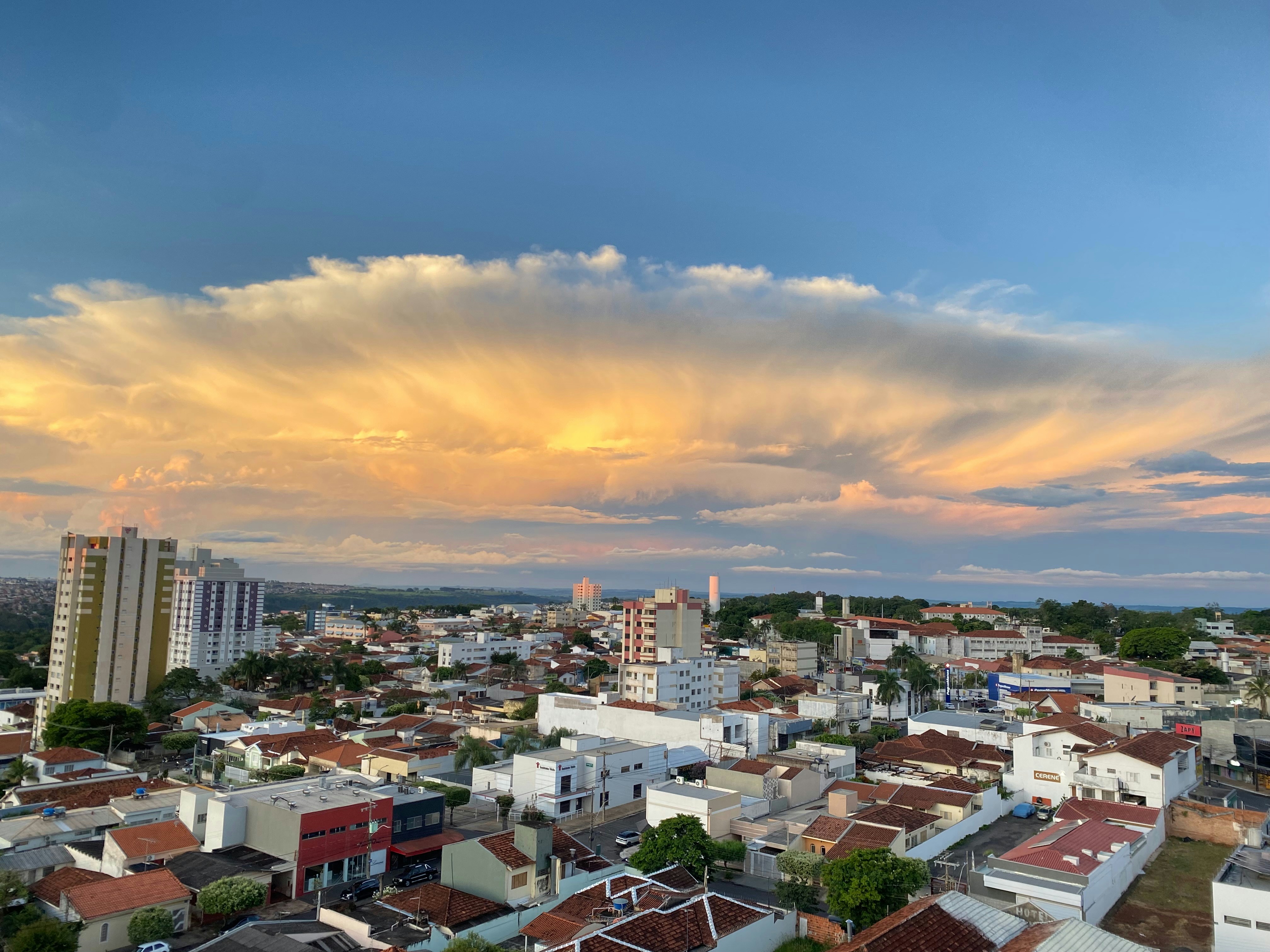Ufo cloud | Cityscape under a vibrant, colorful sunset.