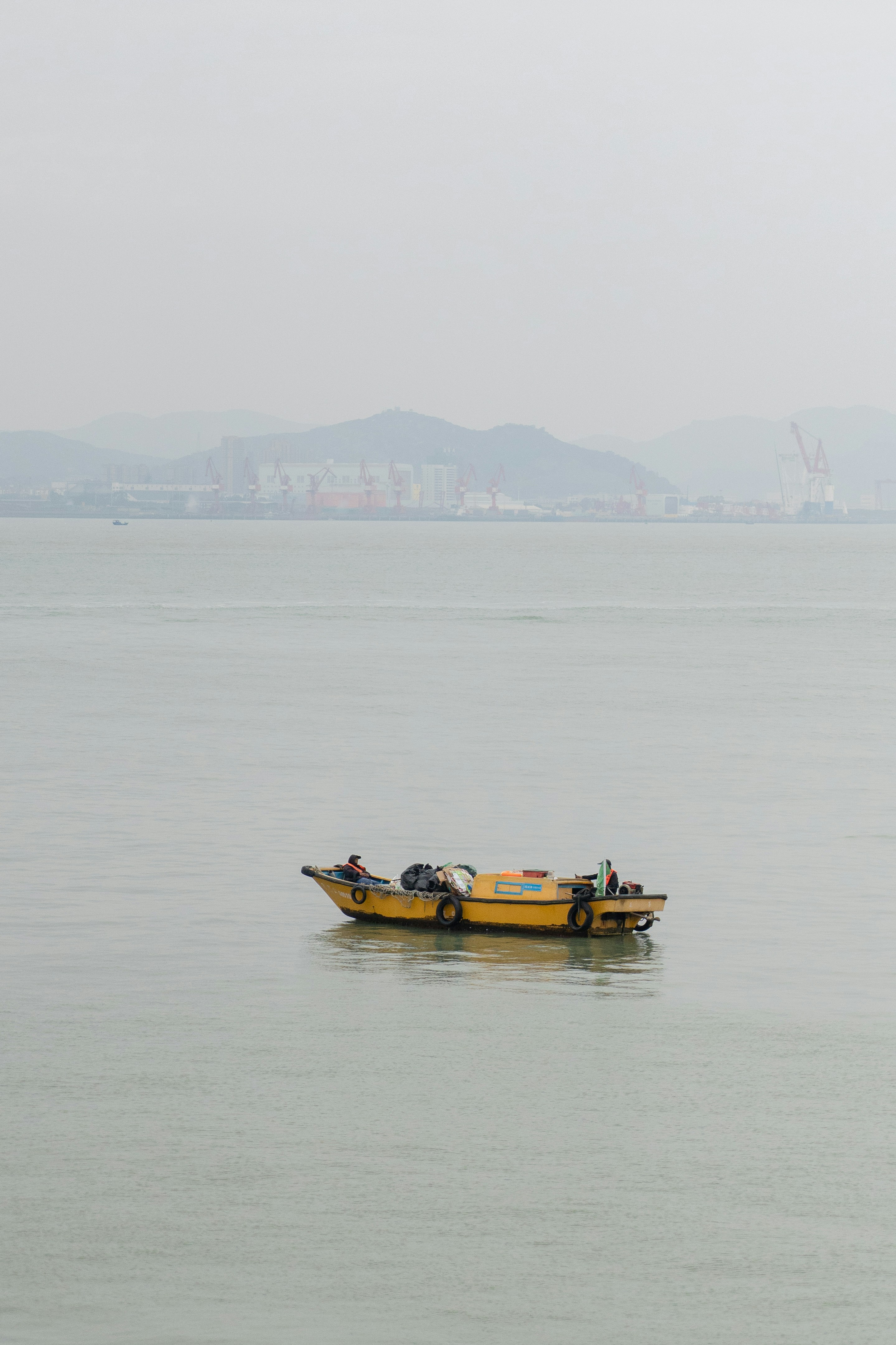 Amber Skiff Drifts Across a Misty River Toward a Distant Harbor