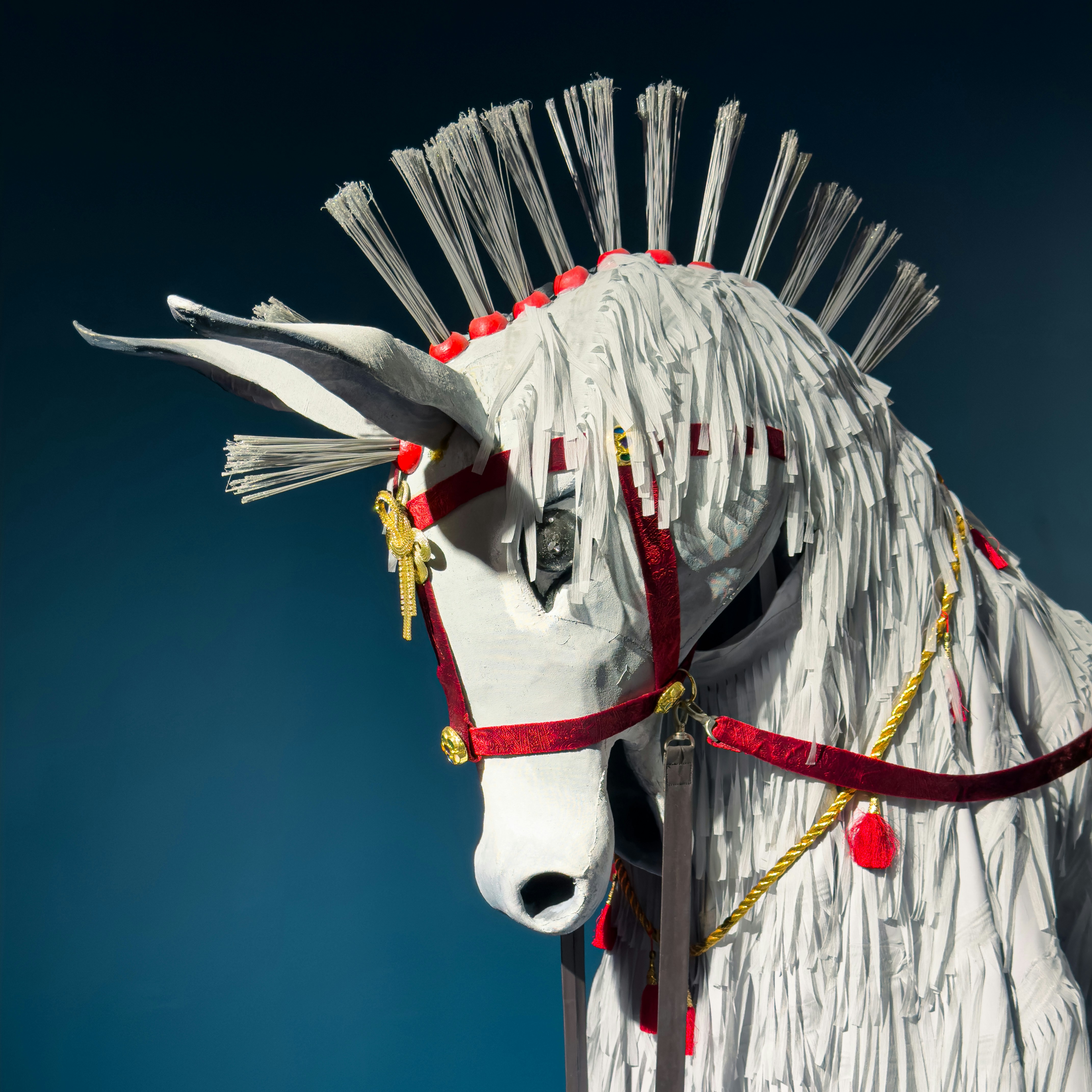 Fringed Carousel Horse in Crisp Contrast Against Deep Indigo