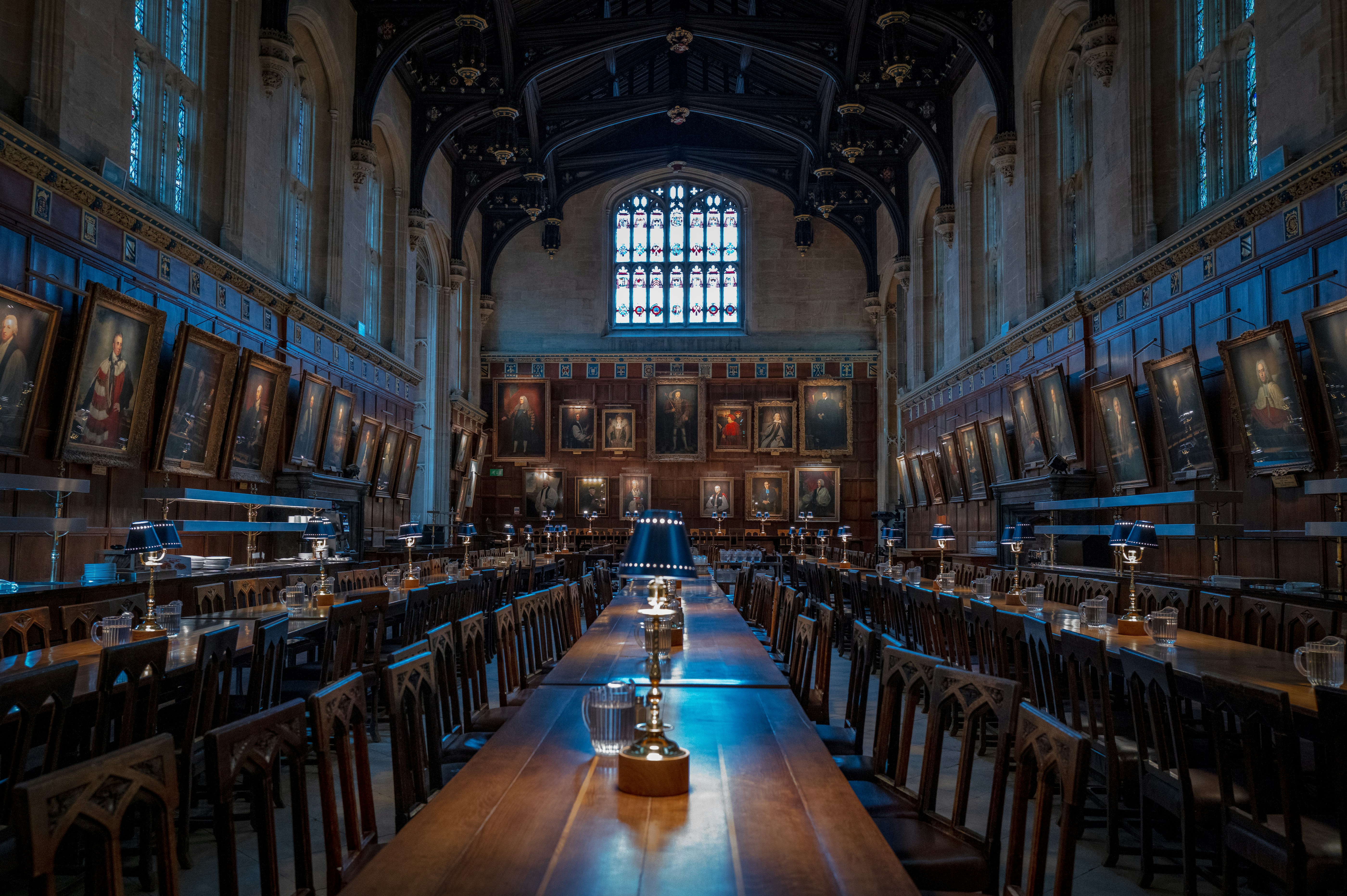 The dining hall features long tables and portraits. photo – Free ...