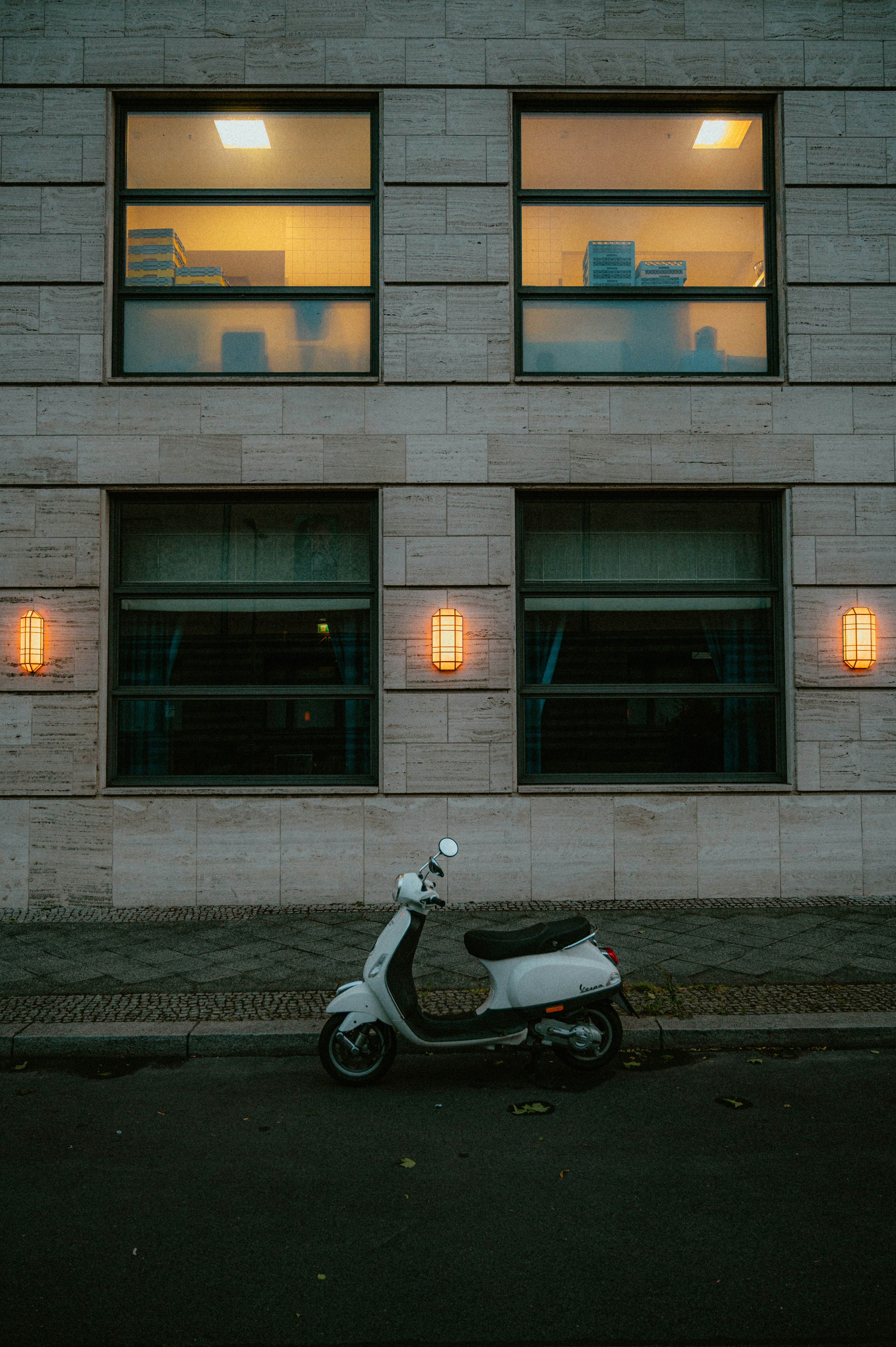 White Scooter Under Evening Windows