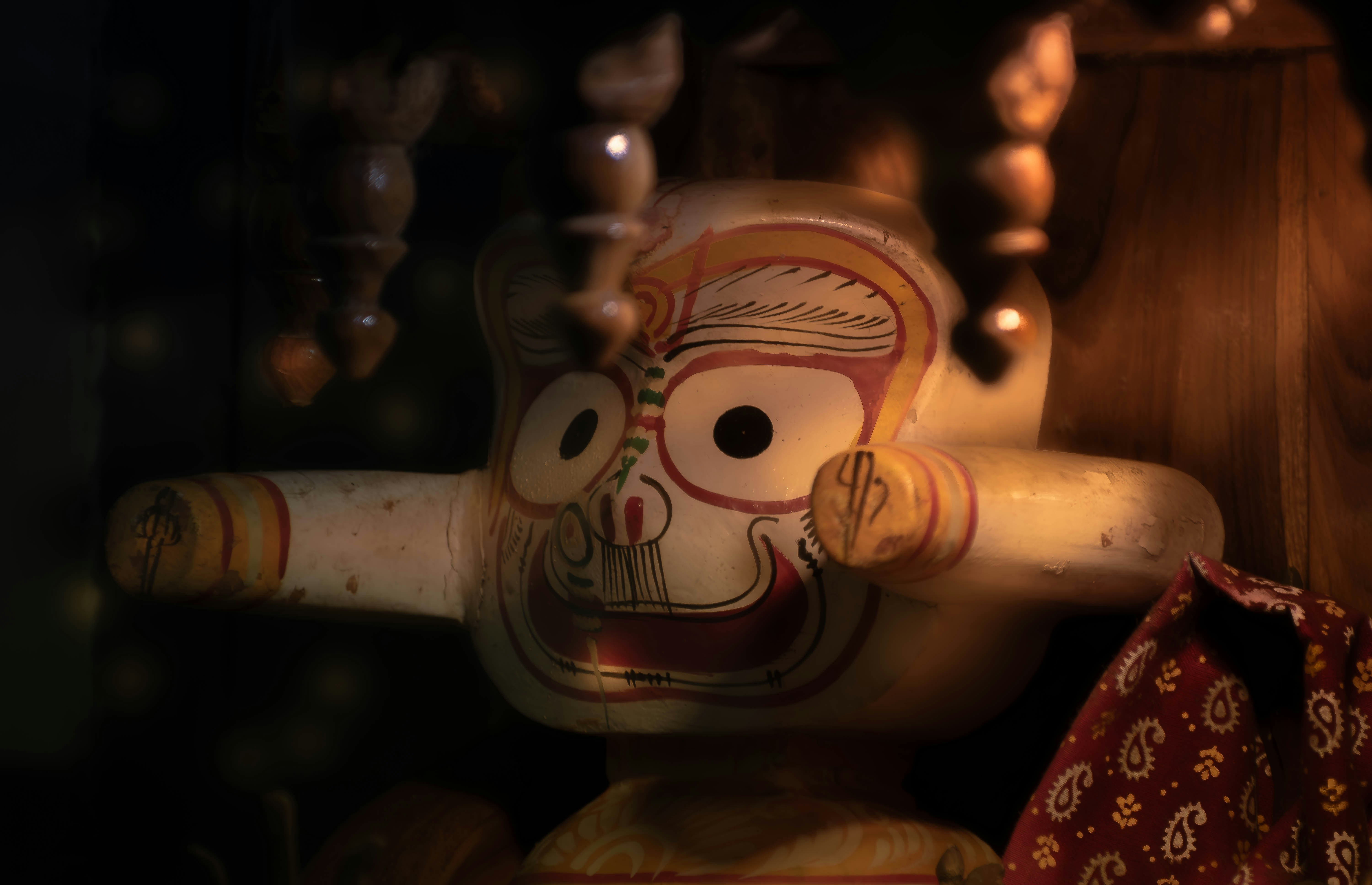 A colorful religious statue with a dramatic dark background.