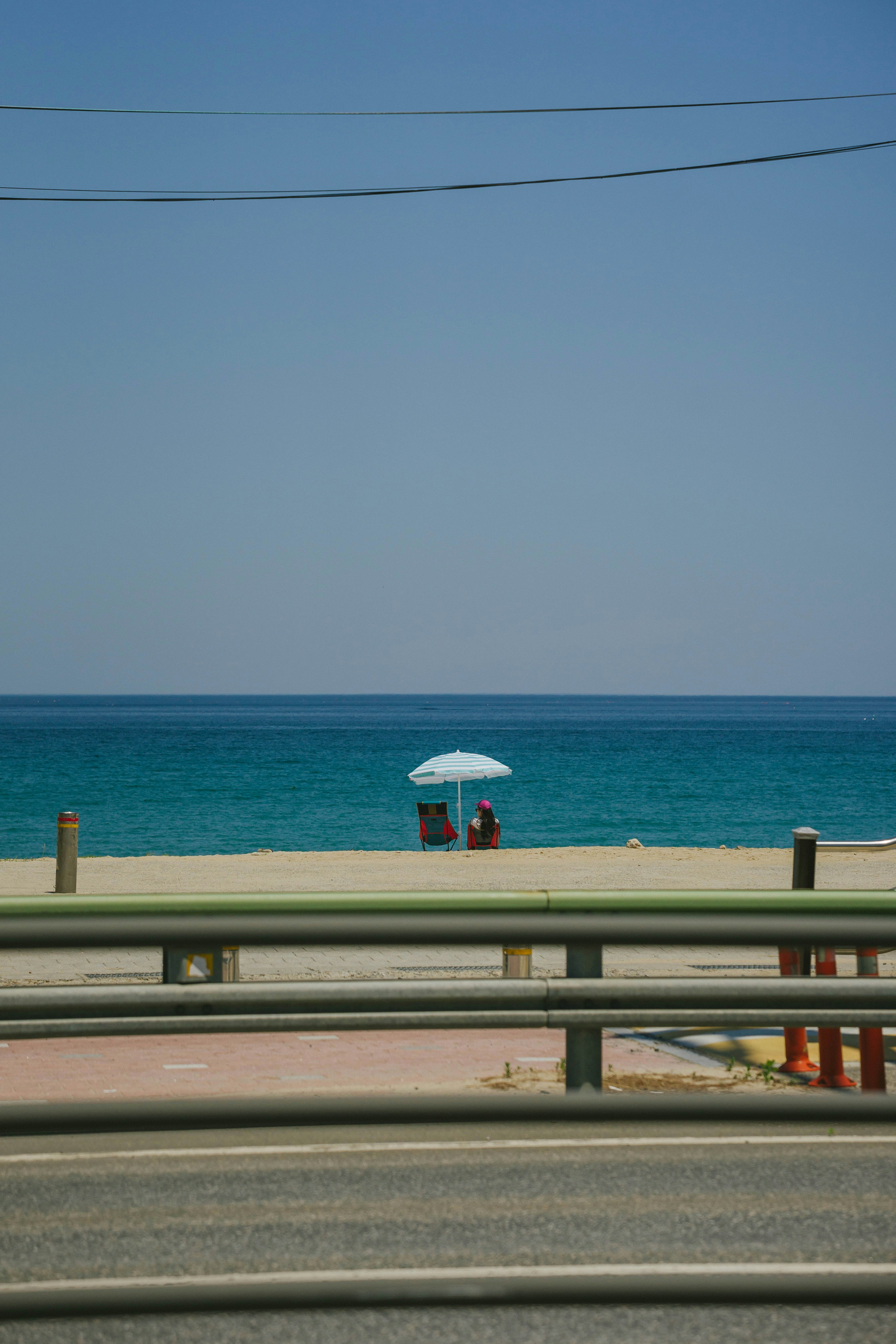 Seaside Serenity: A Moment Under the Umbrella