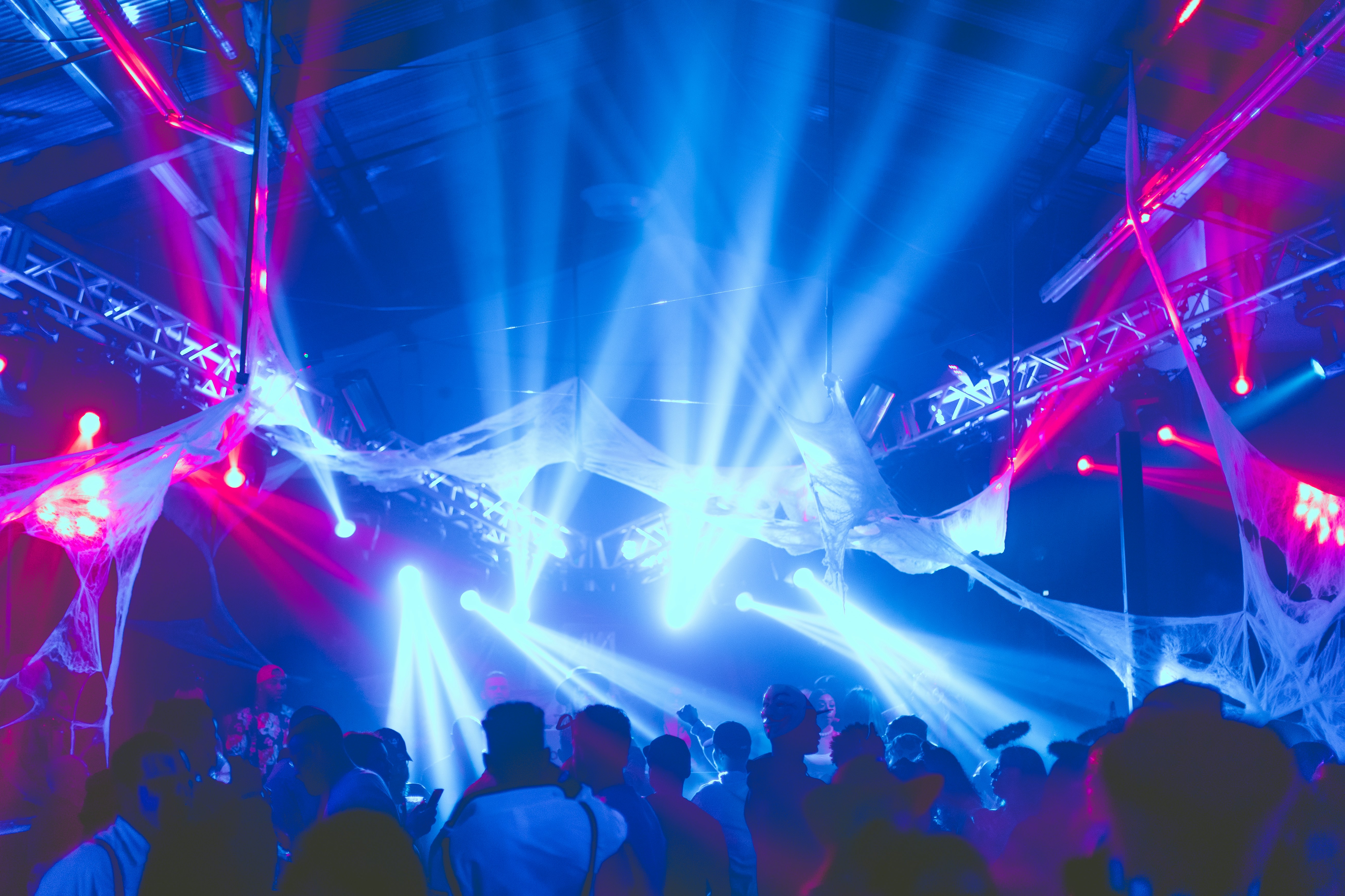 Night time party in Los Angeles, California | People dance under bright lights at a concert.