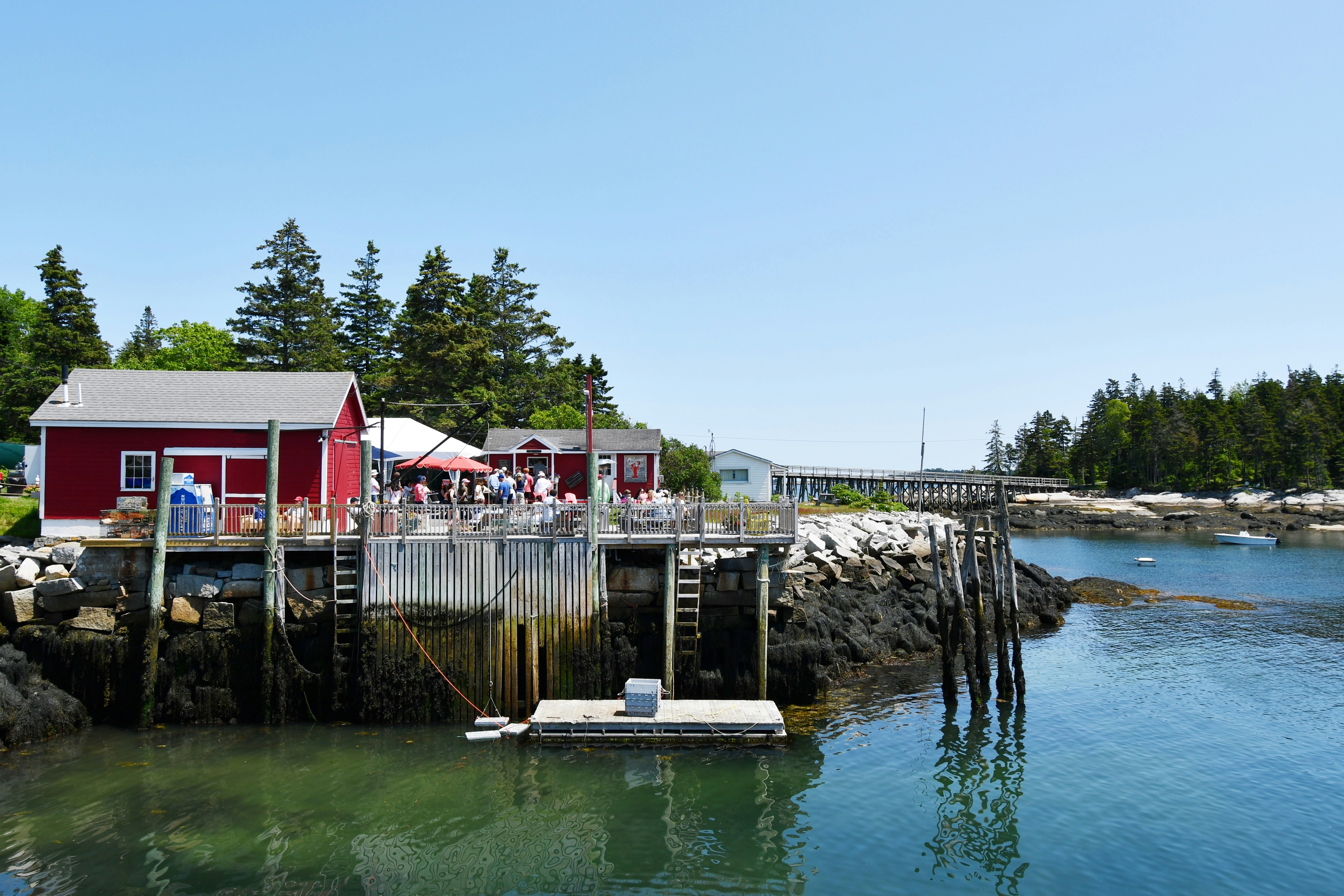 A lobster shack in Maine | A red building sits on a wooden dock.
