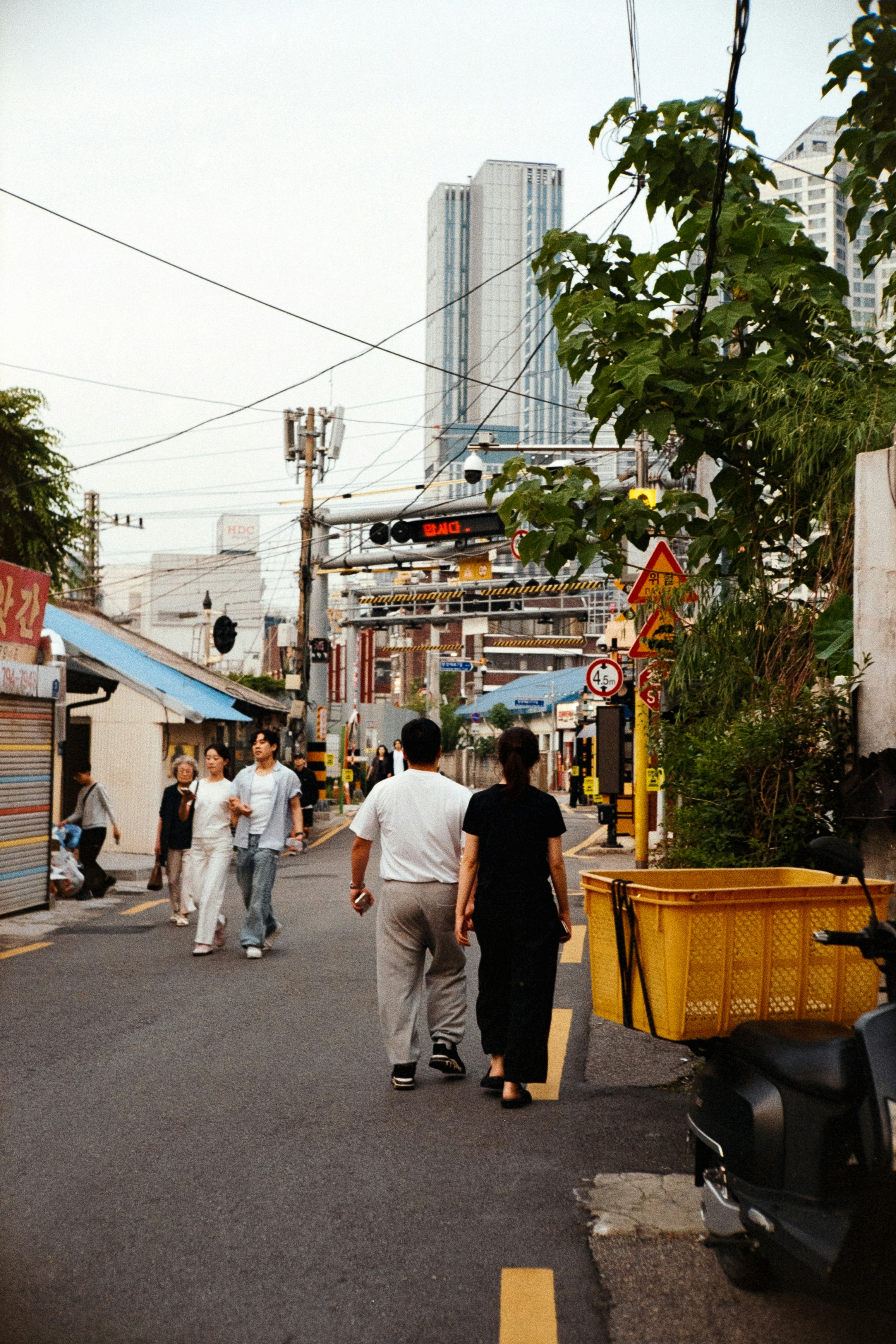 People walk down a street in the city.