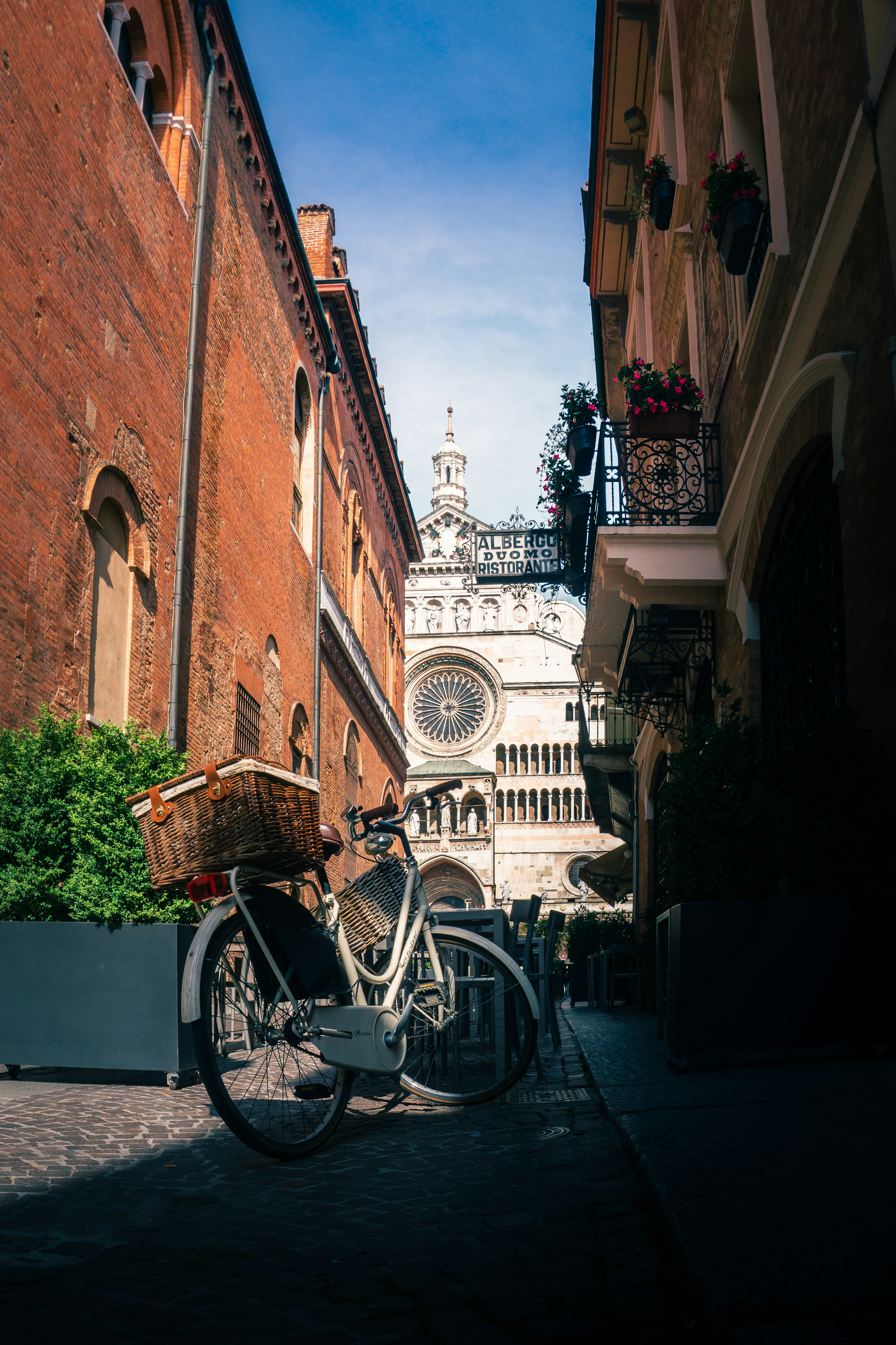 A bicycle parks in front of a cathedral.
