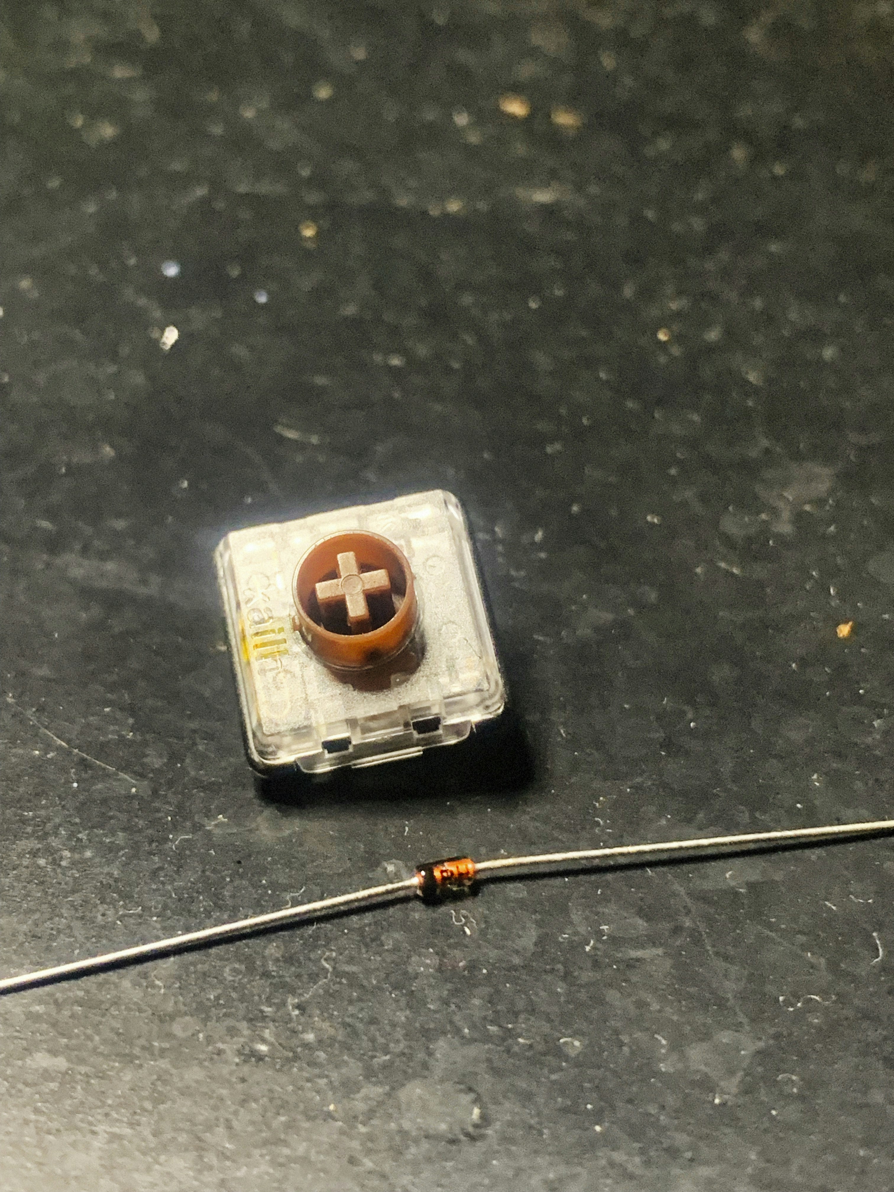 Keyboard switch and diode are placed on a surface.
