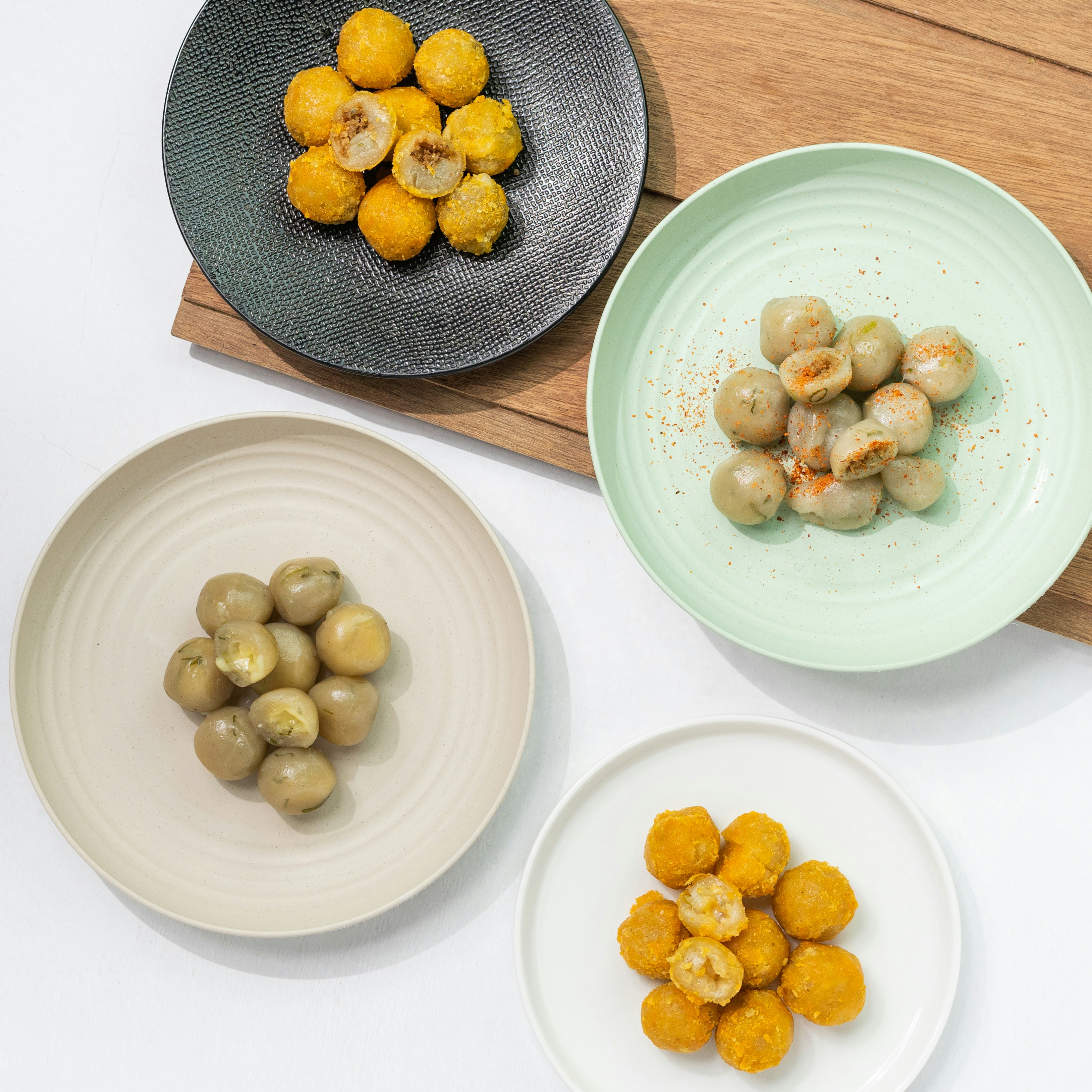 Orbs on Ceramic: A Flat-Lay Study of Golden Dumplings and Fried Balls