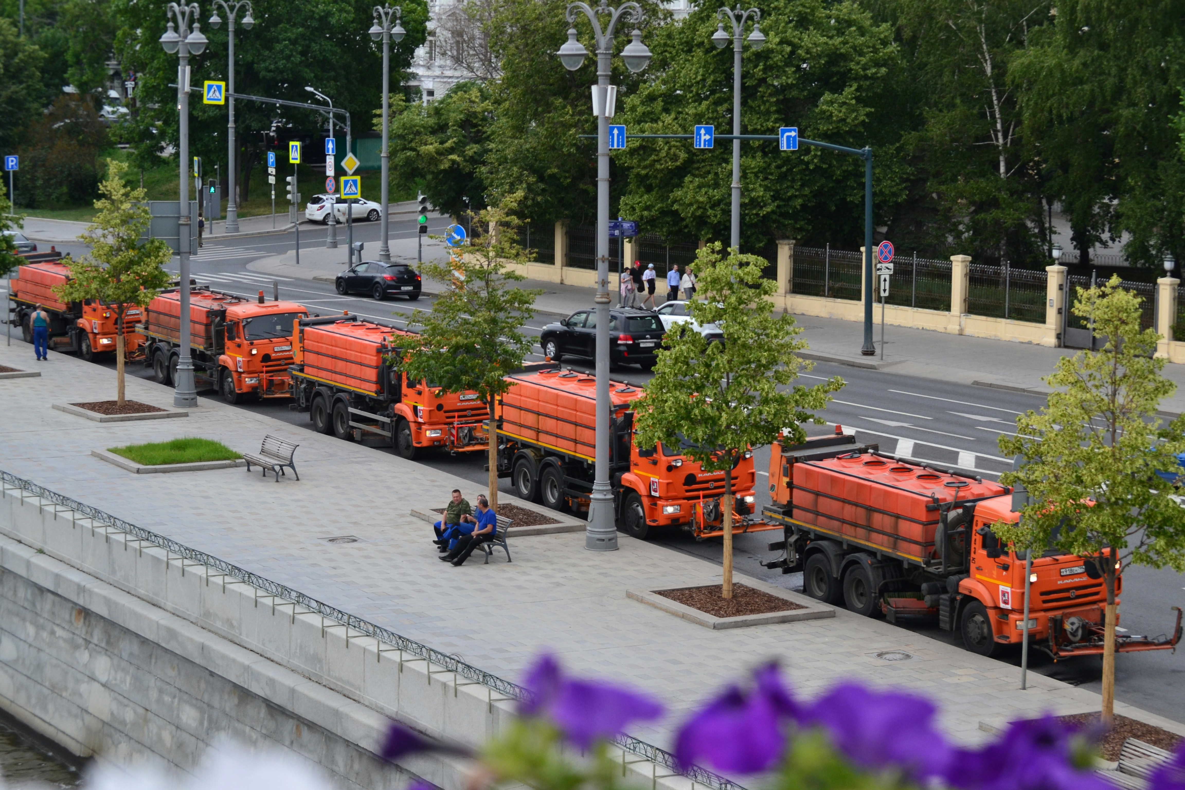 Orange Convoy Along the Riverside Promenade