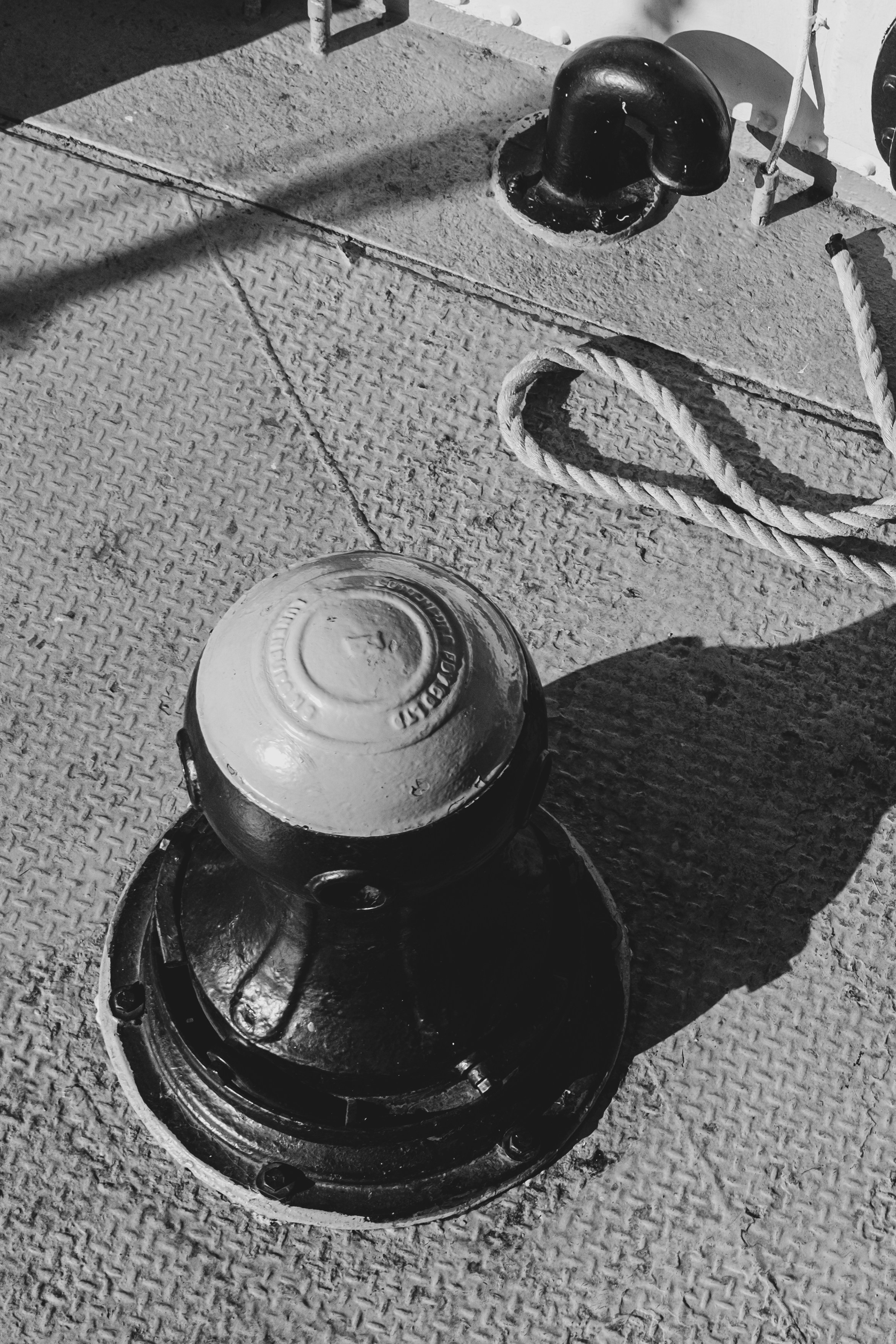 Rope and Cleat on a Textured Deck under Harsh Light