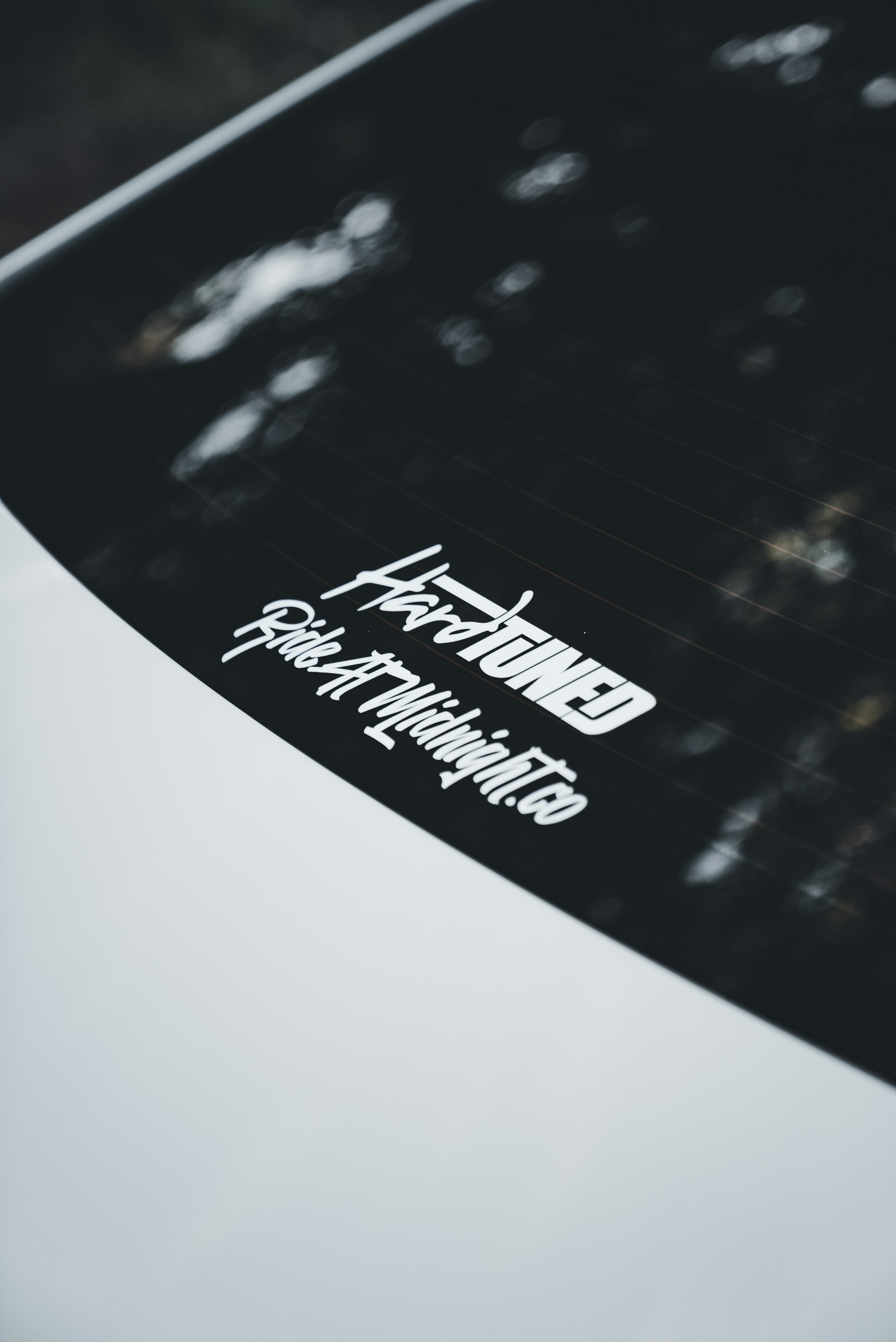 A sticker on a car window reads "hard tuned." photo – Free Car Image on ...