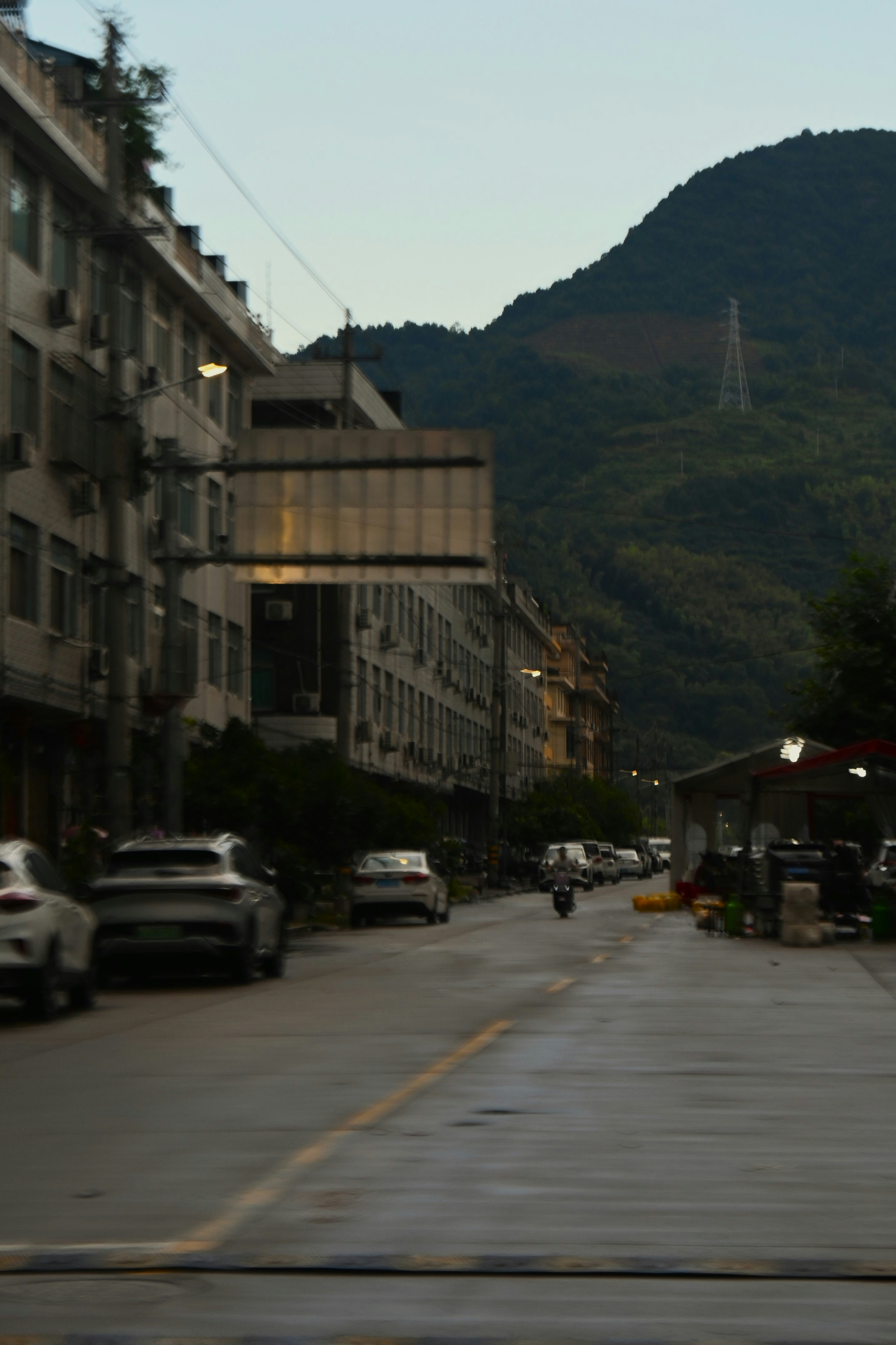 City street with mountain in background.