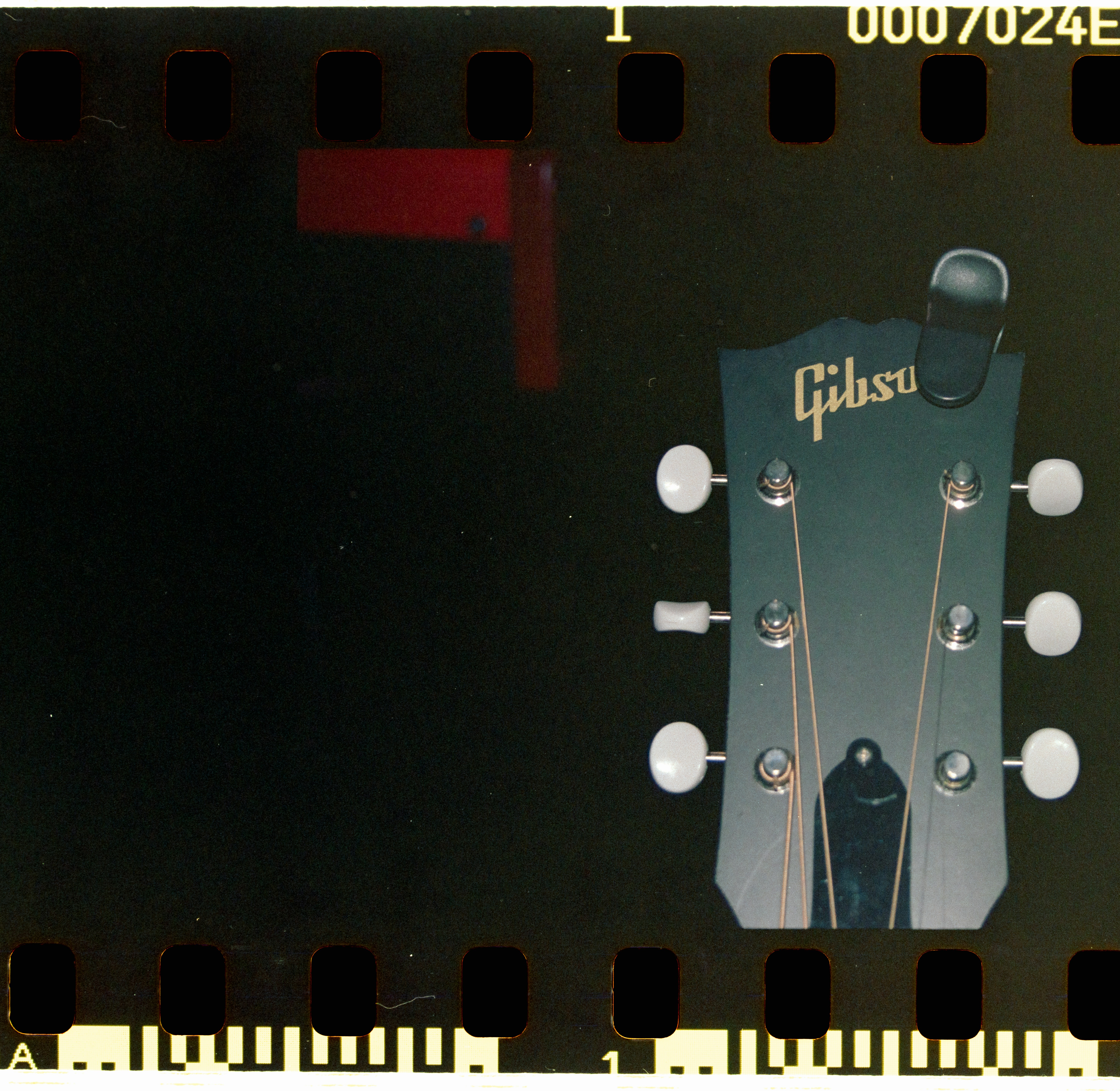 A gibson guitar's headstock on film.