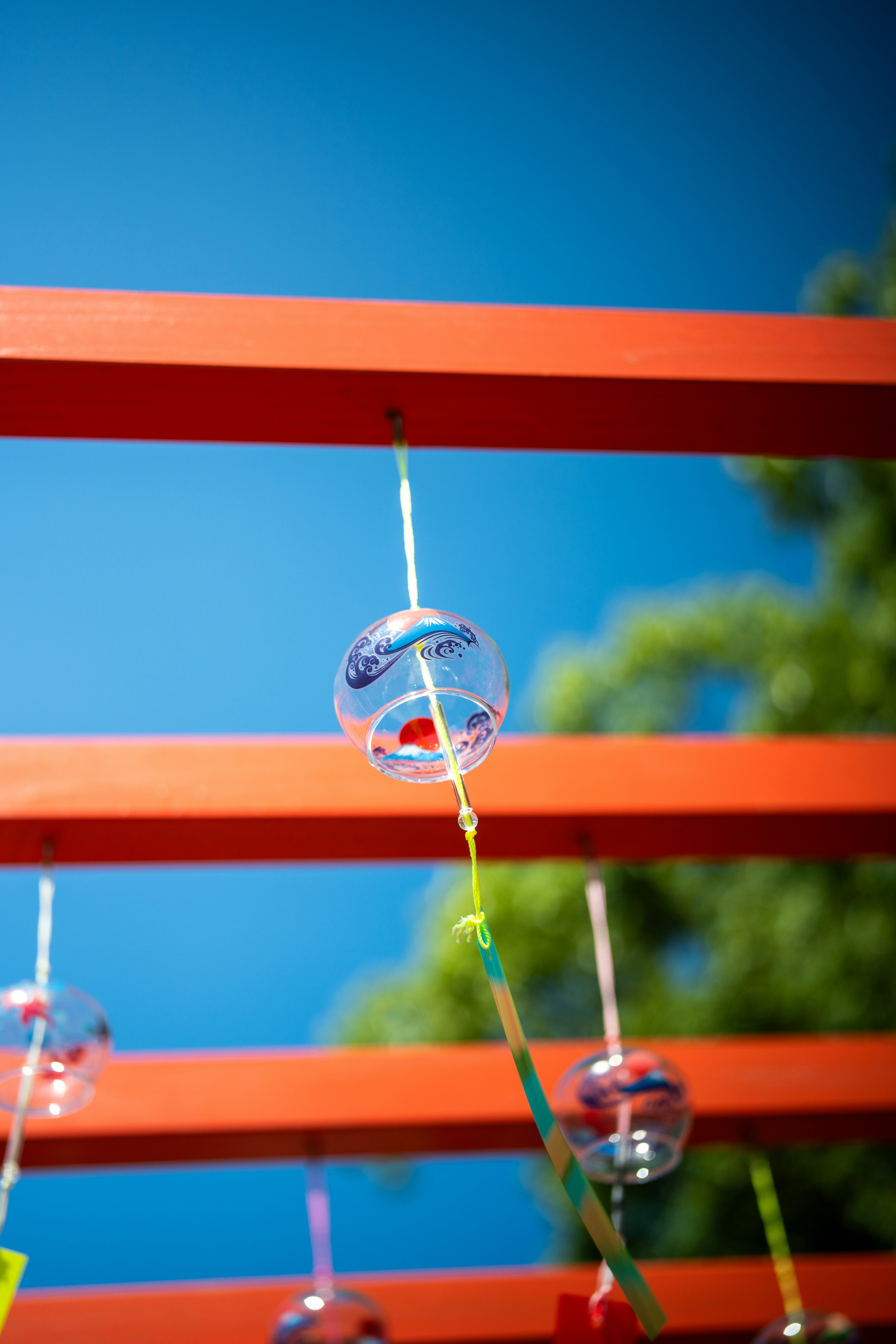 Glass wind chimes hang under a bright blue sky. photo – Free City Image ...