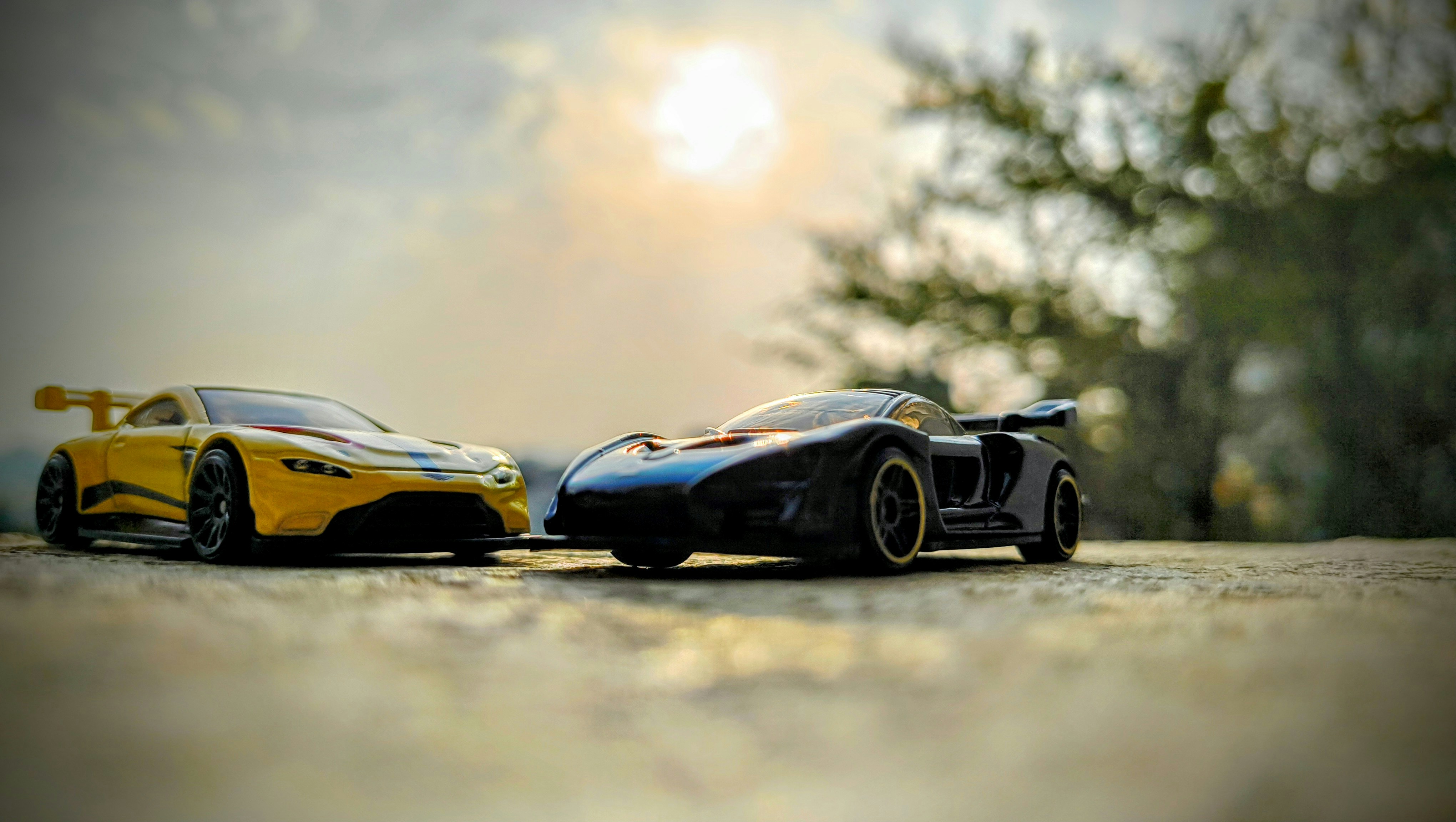 Hood on Left in Yellow Aston Martin Vantage GTE on Right Black Mclaren P1 Senna GT